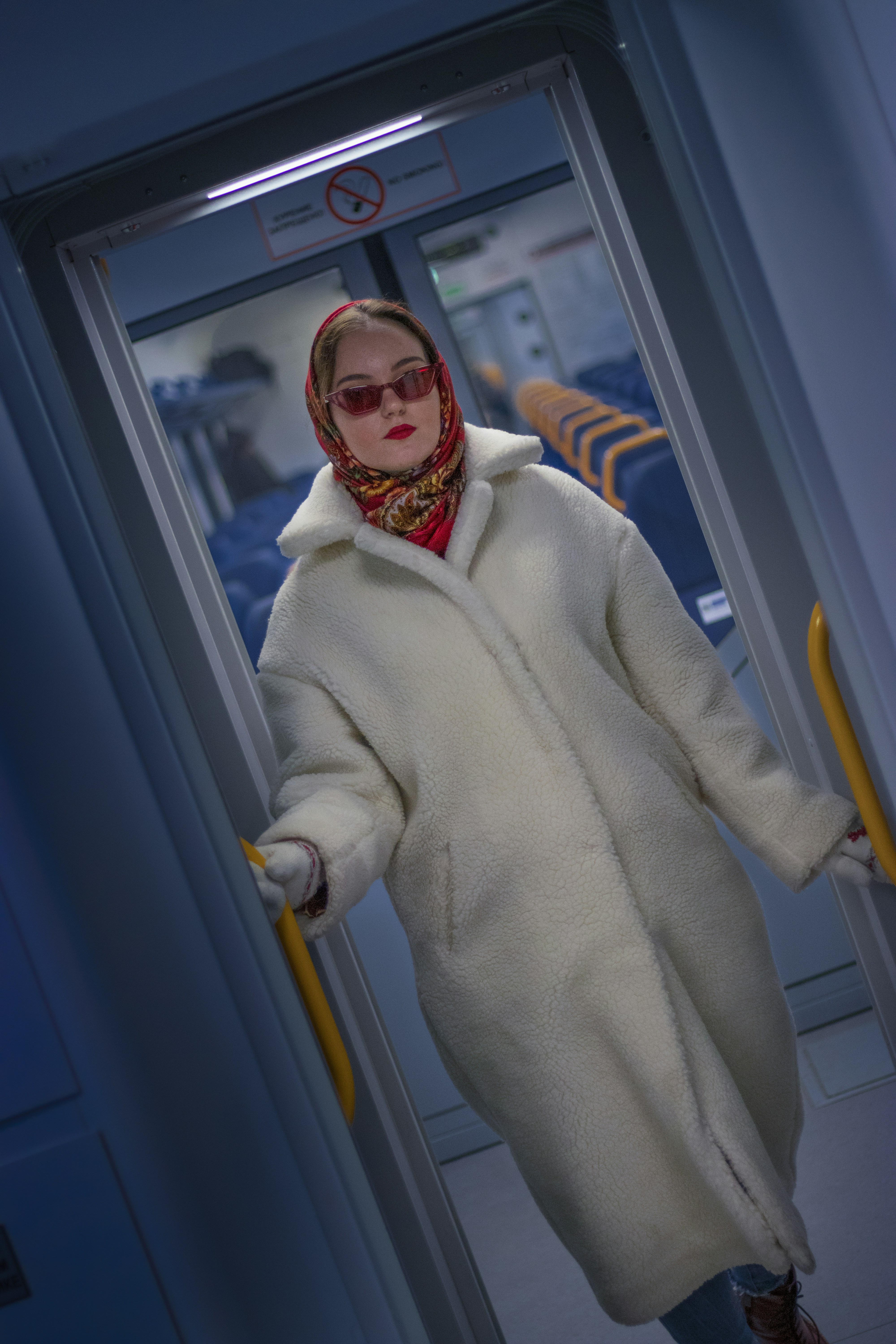 Snow-White Coat at the Metro Threshold: A Portrait of Color and Contrast