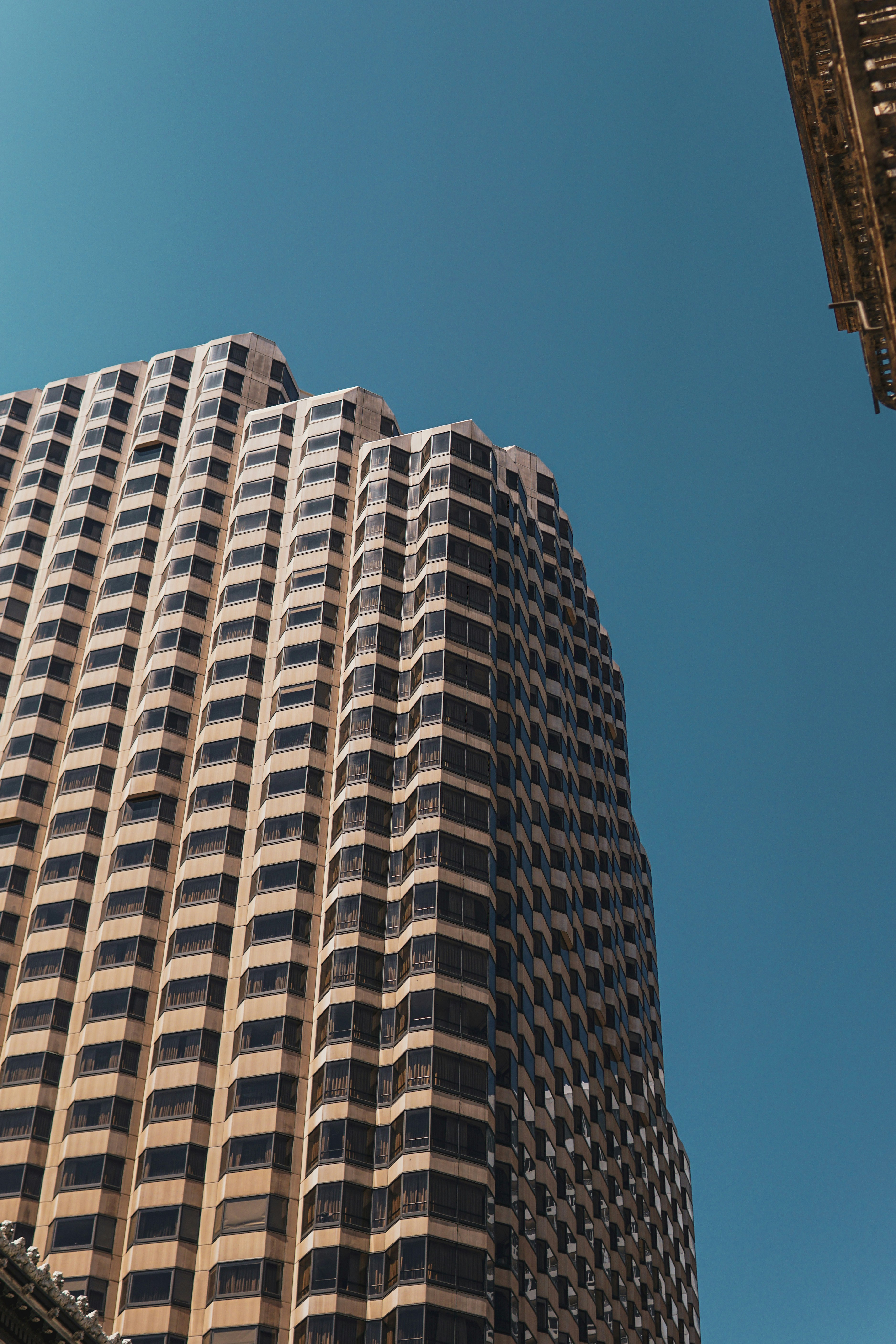 A very tall building towering over a city photo – Free Financial ...