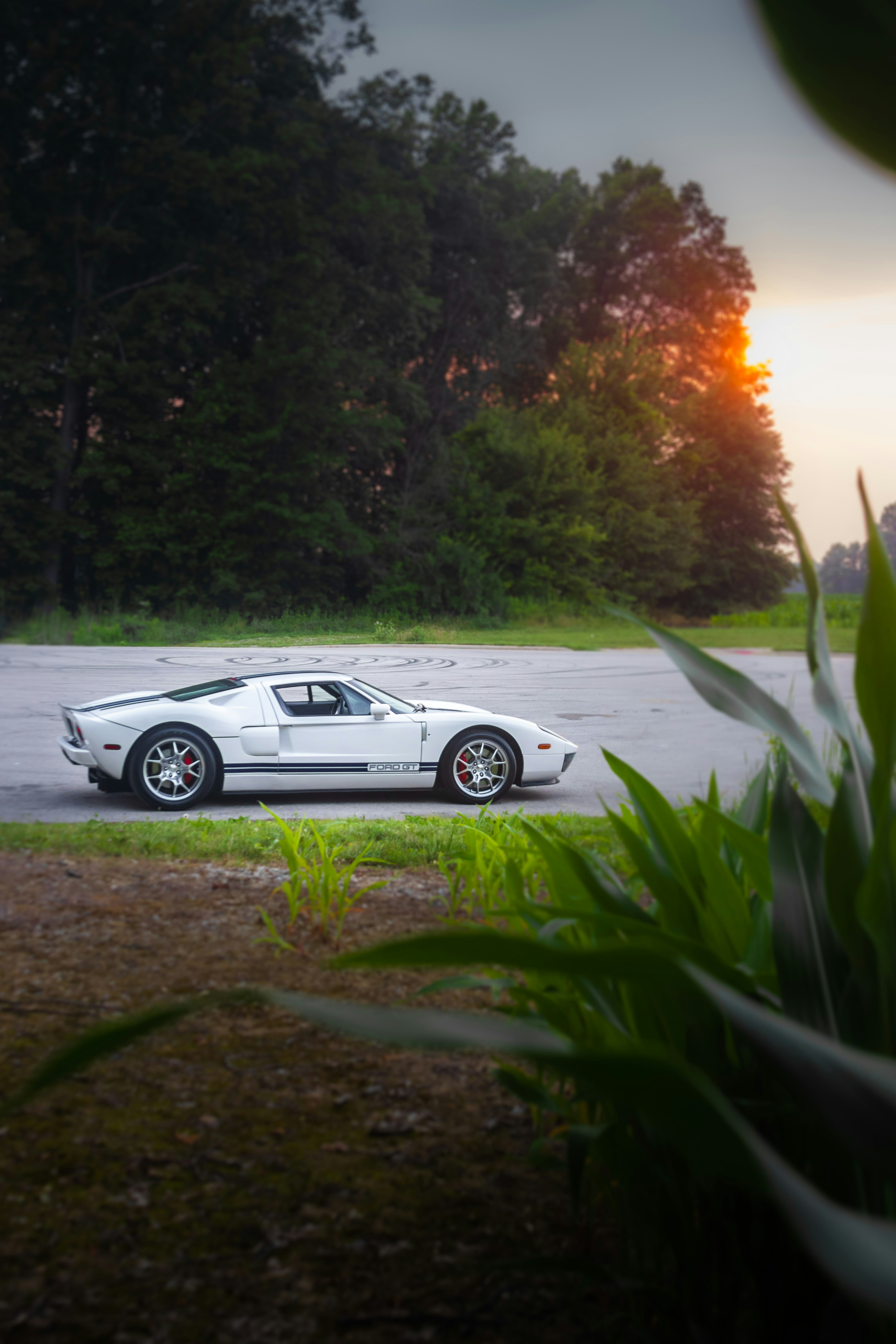 Dusk Spotlight on a White Classic Sports Car Along a Quiet Country Road