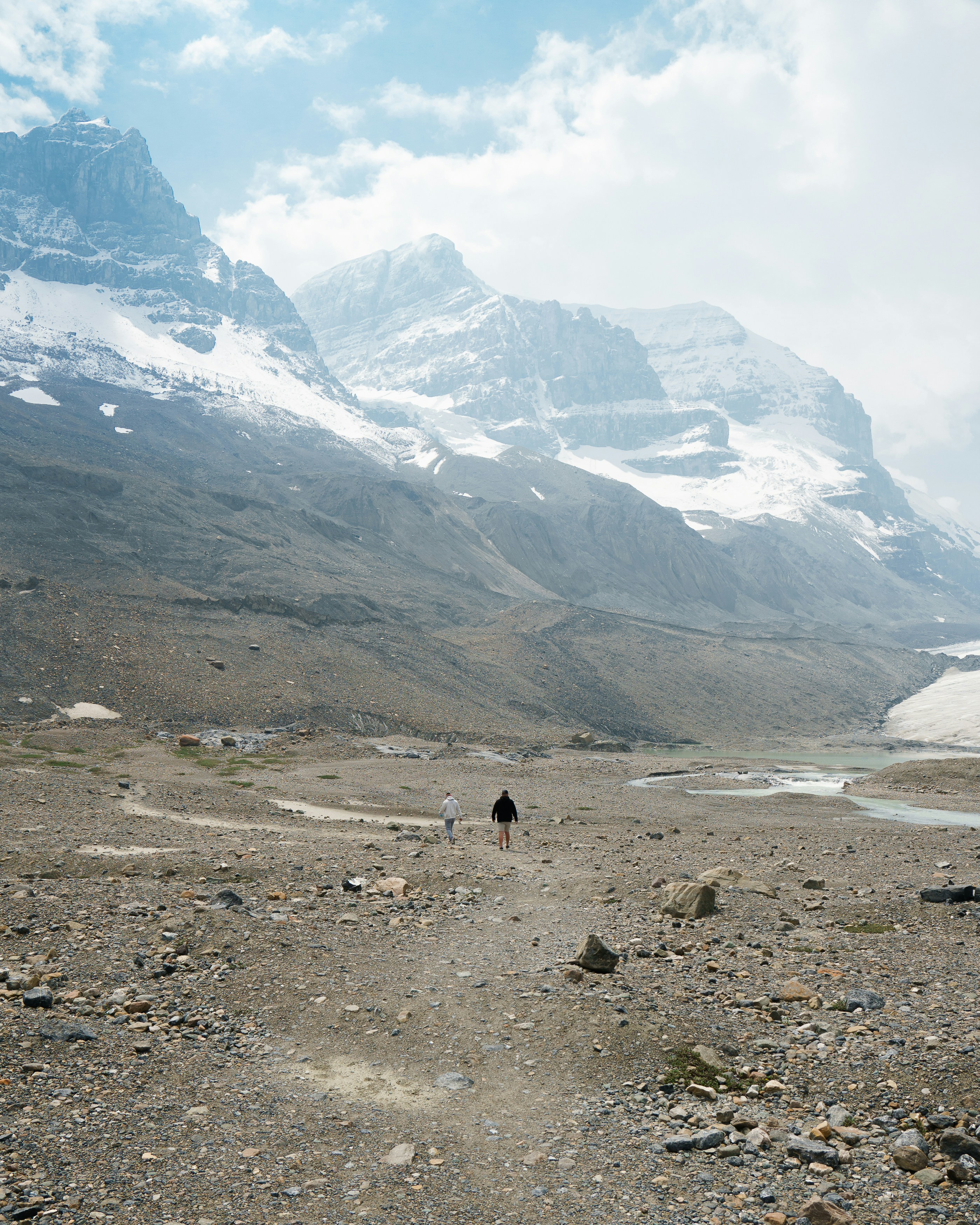 A person walking on a rocky path in the mountains photo – Free ...