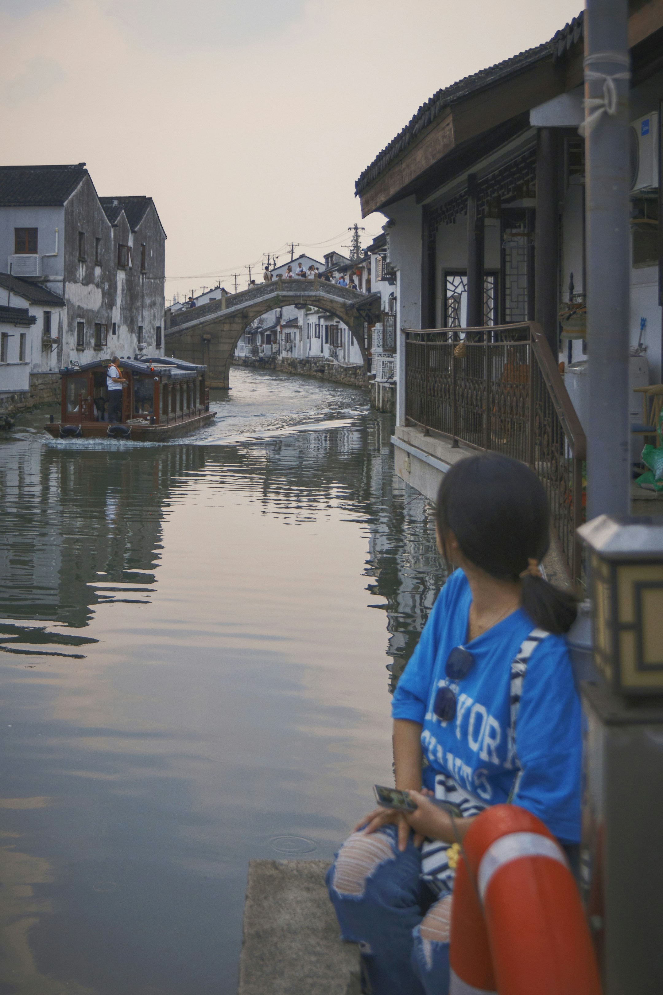 Quiet Canal Portrait: A Child on the Riverside Edge