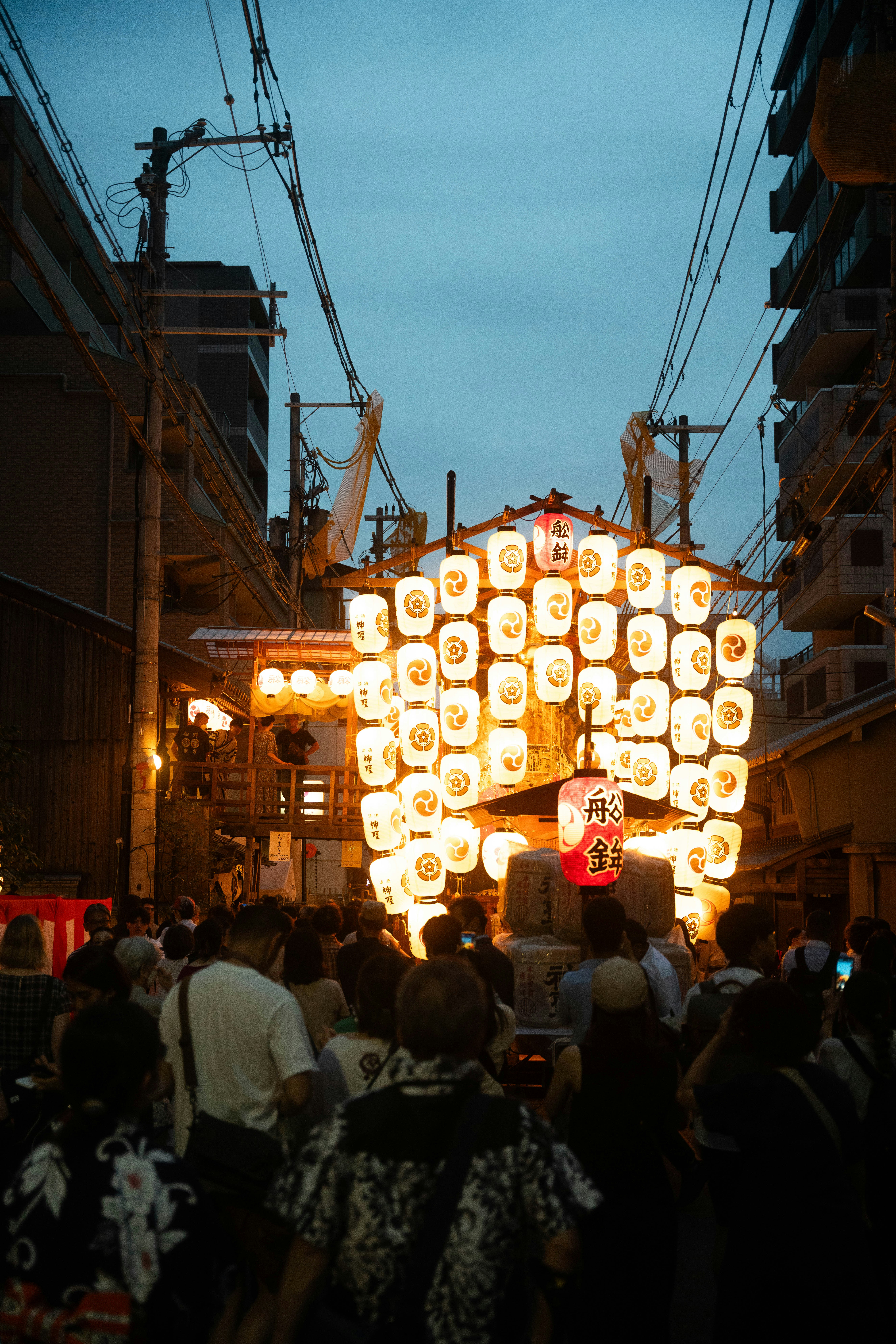Urban Lantern Parade: Warm Orbs Illuminate a Crowded Night Street