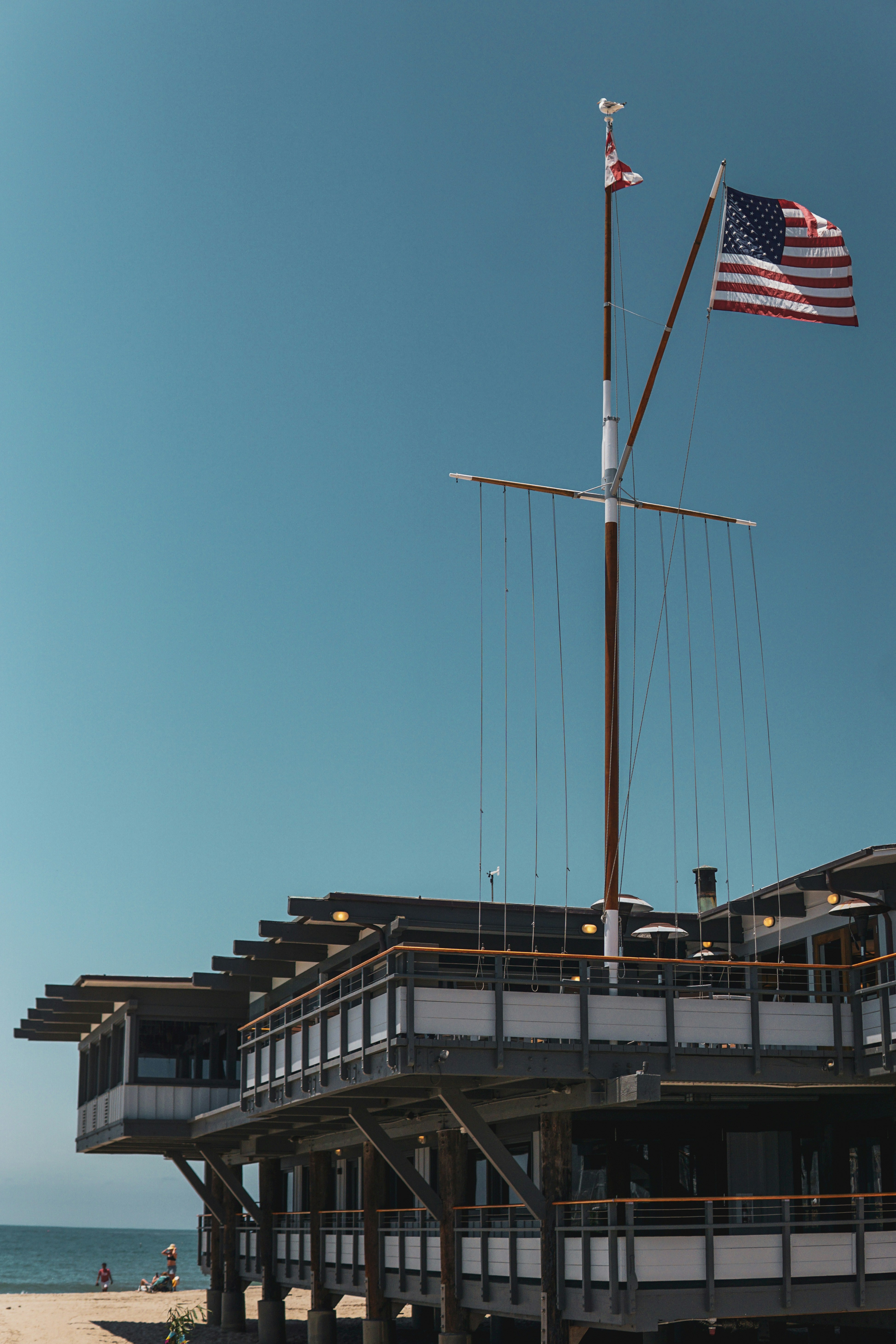 Flagpole Sentinel Over a Seaside Pier