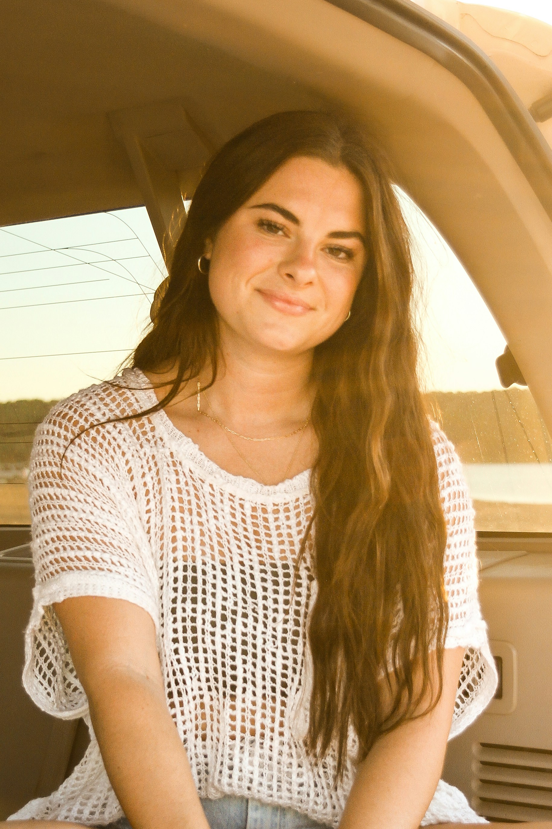 Sunlit Portrait in a Warm Cab: A Soft Gaze Beneath Convertible Light