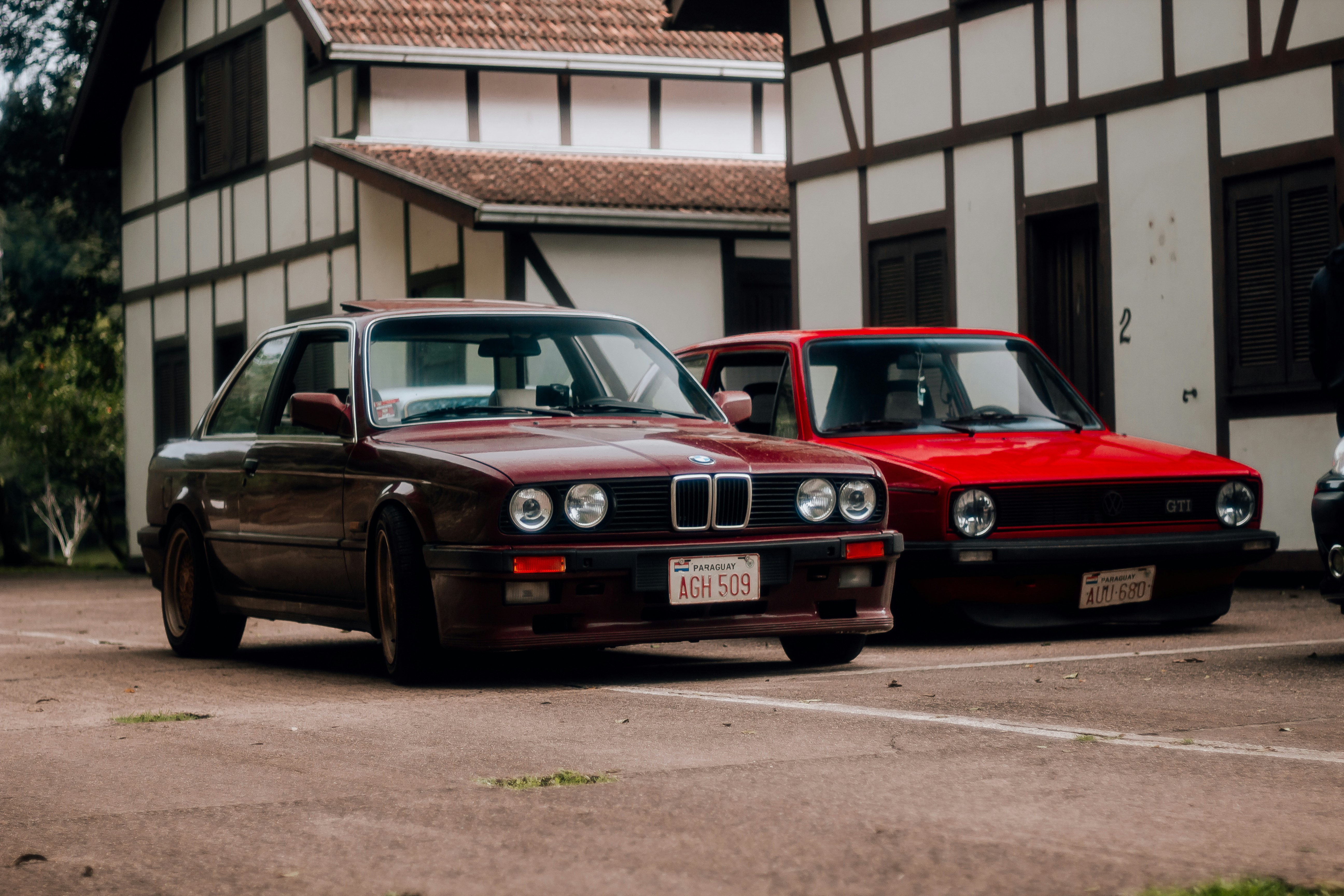 Two Classic BMWs Guard the Courtyard Between Timber-framed Facades