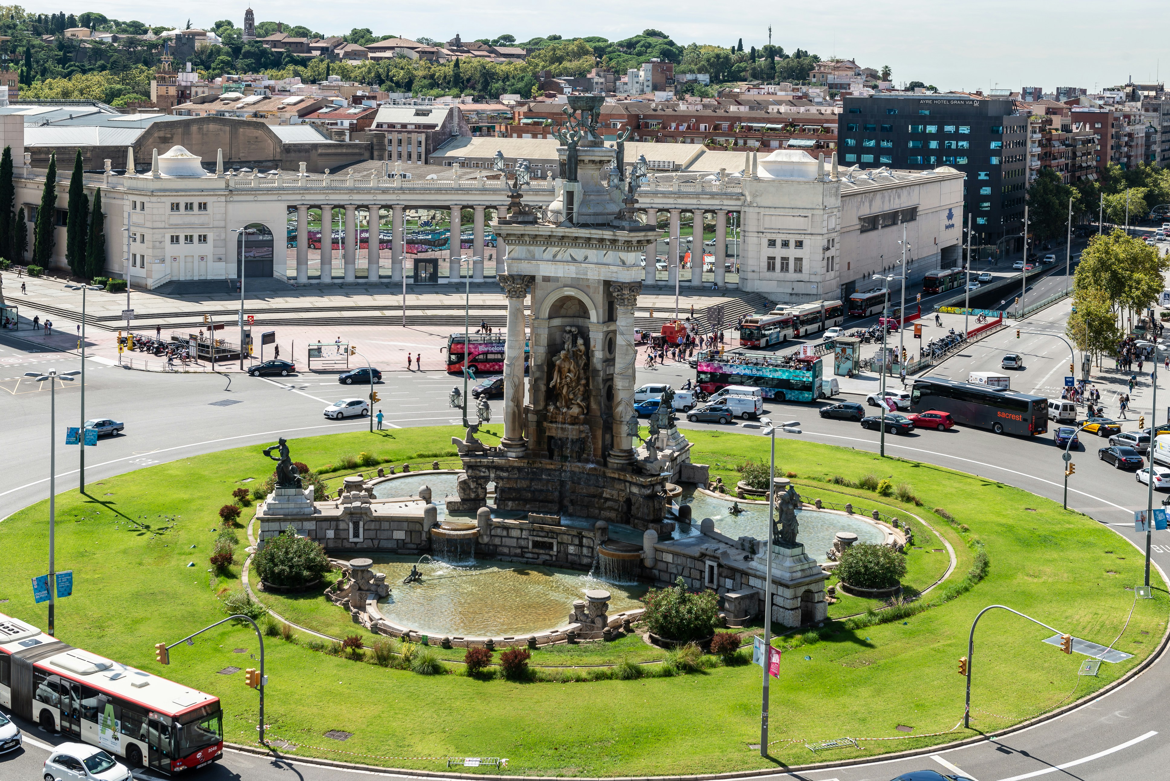A clock tower in the middle of a roundabout photo – Free Car Image on ...