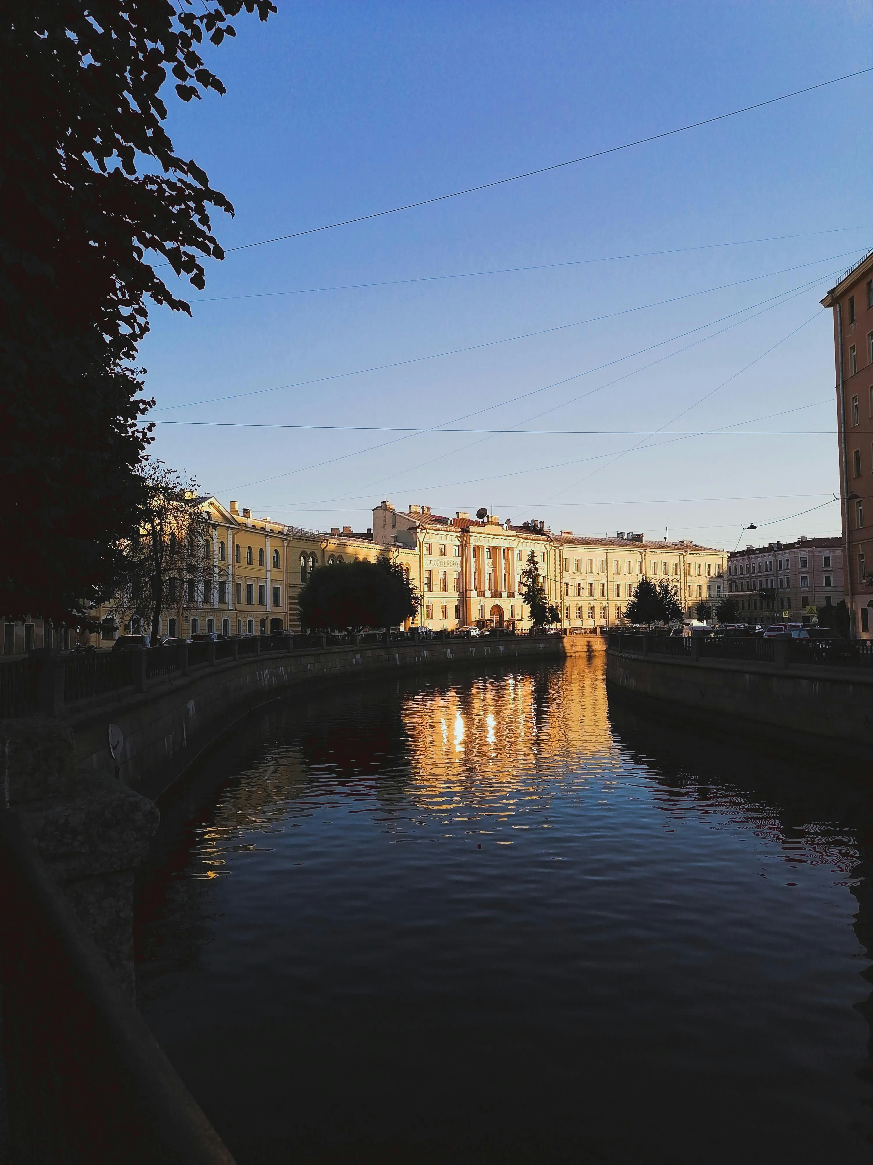A river running through a city next to tall buildings photo – Free City ...