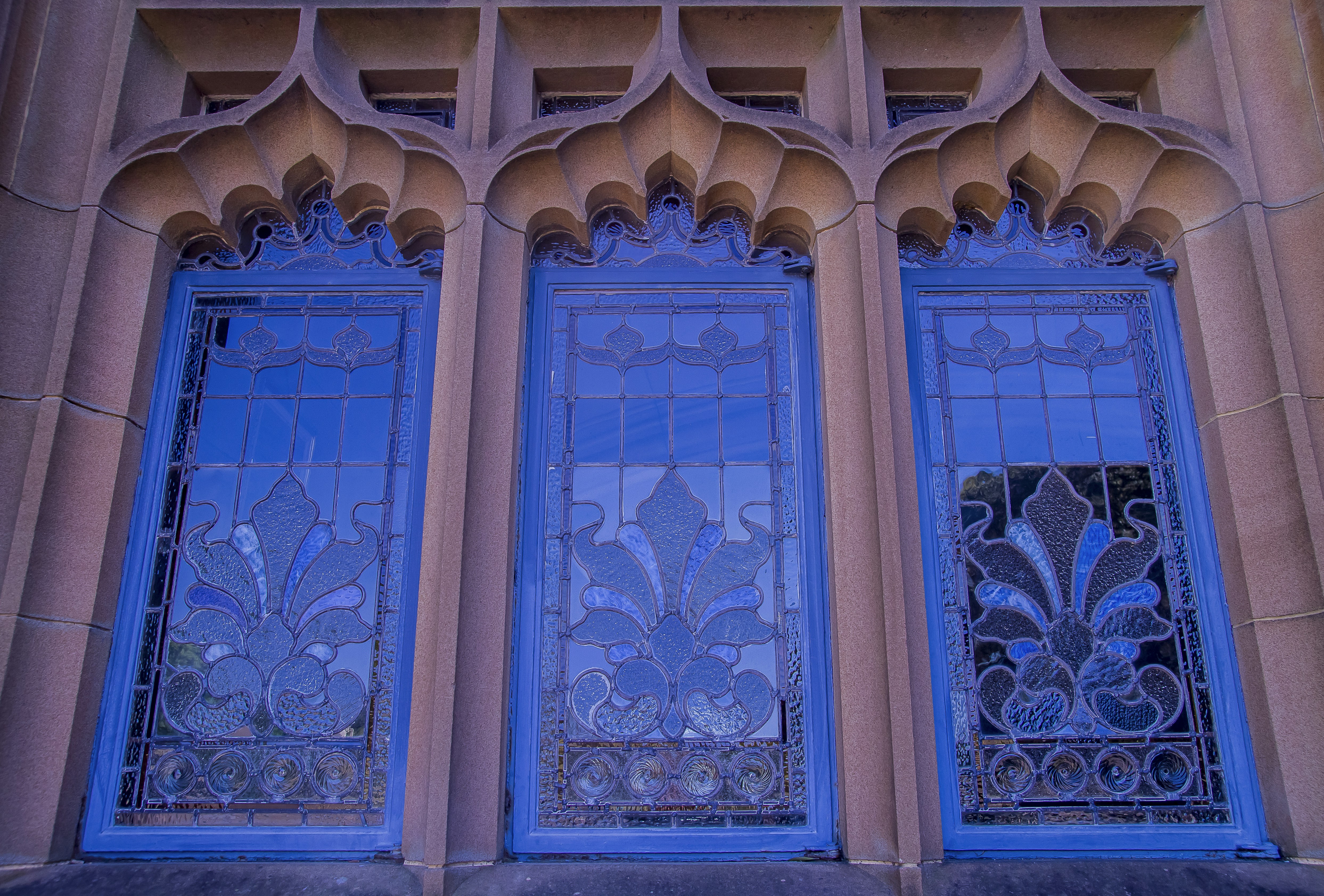 Azure Tracery: Central Window Framed by Ornate Terracotta Arches