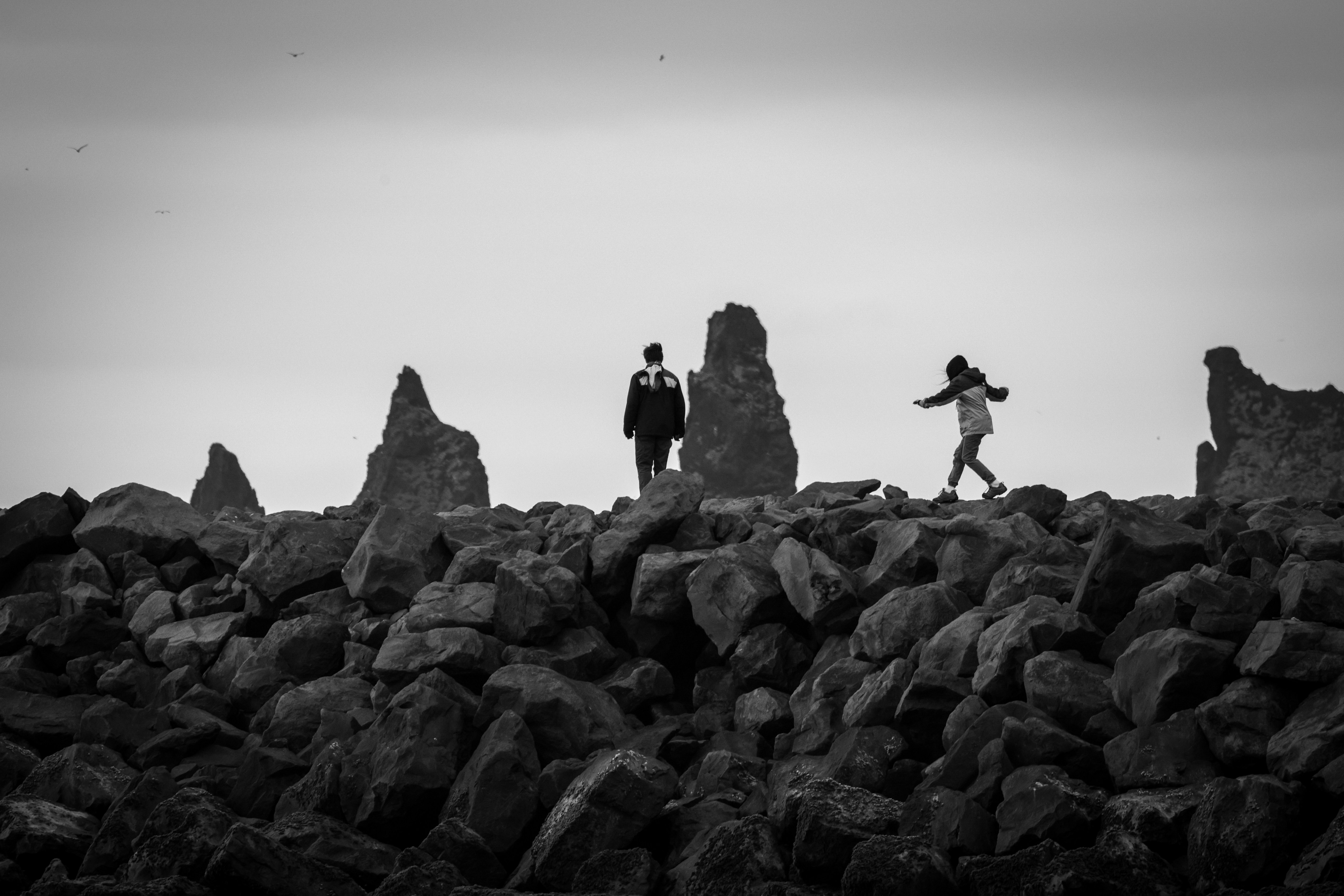a couple of people that are standing on some rocks