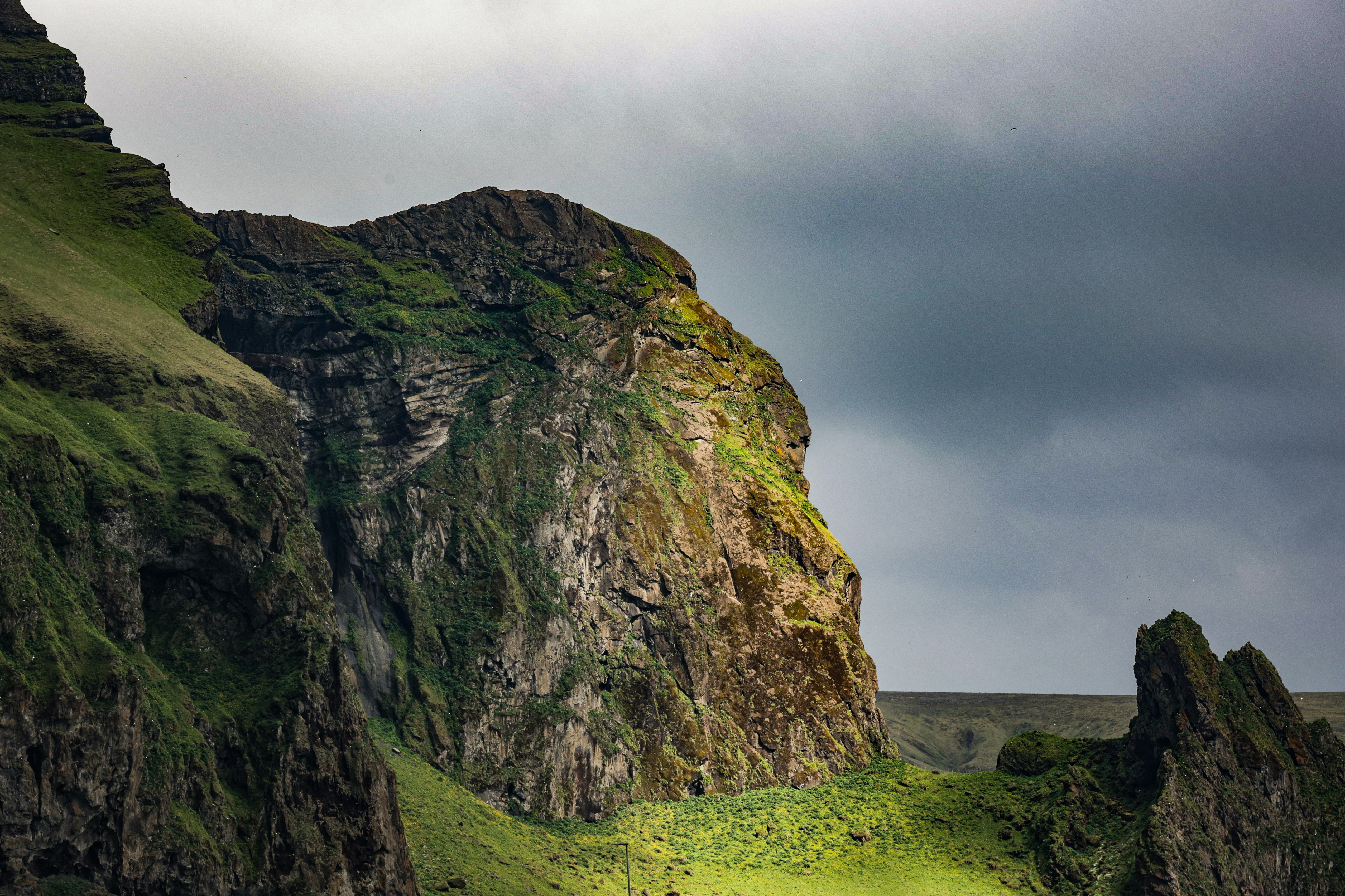 Verdant Cliff Face under a Moody Atlantic Sky
