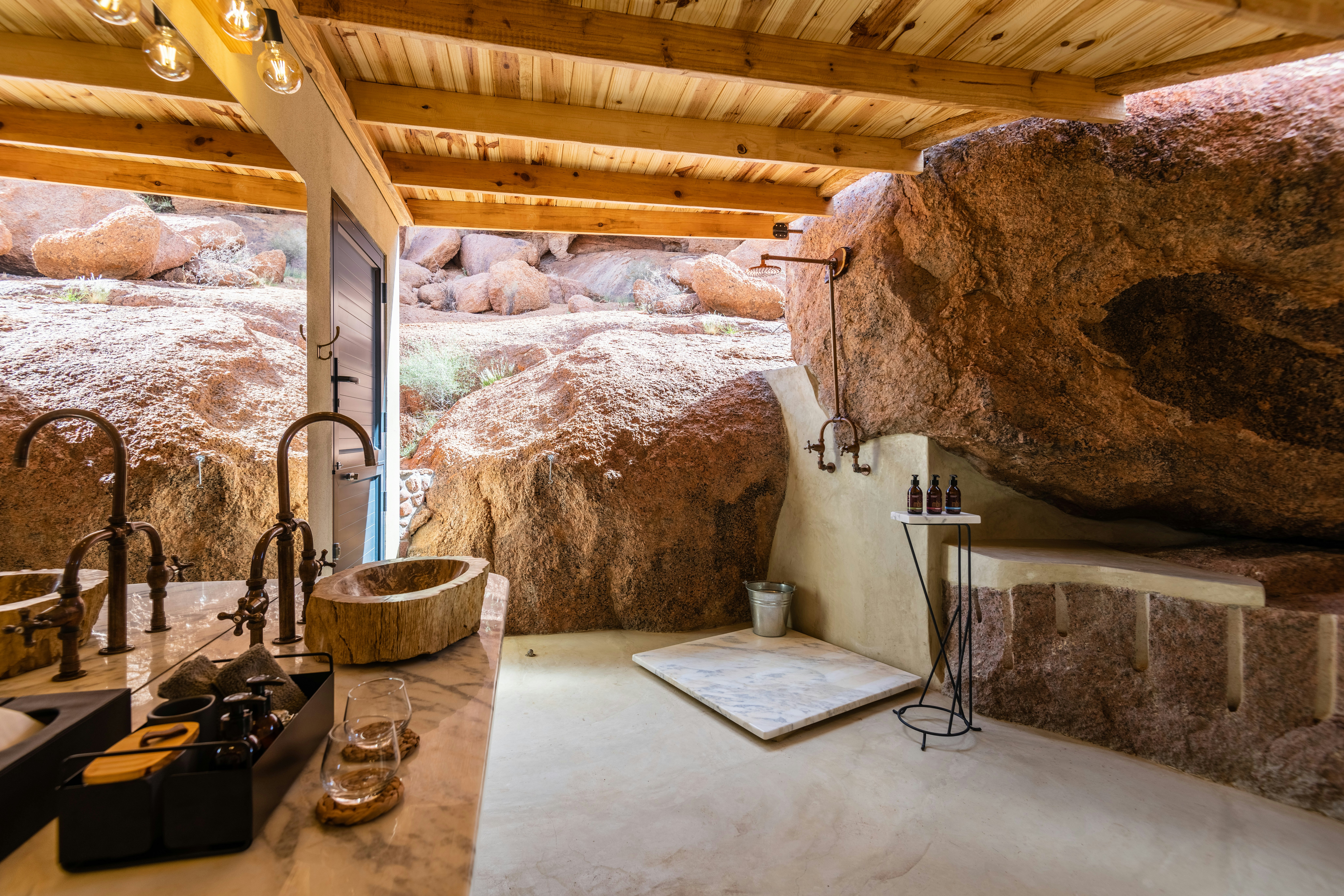 Cavern Spa Studio: Stone Sink Beneath a Wooden Roof