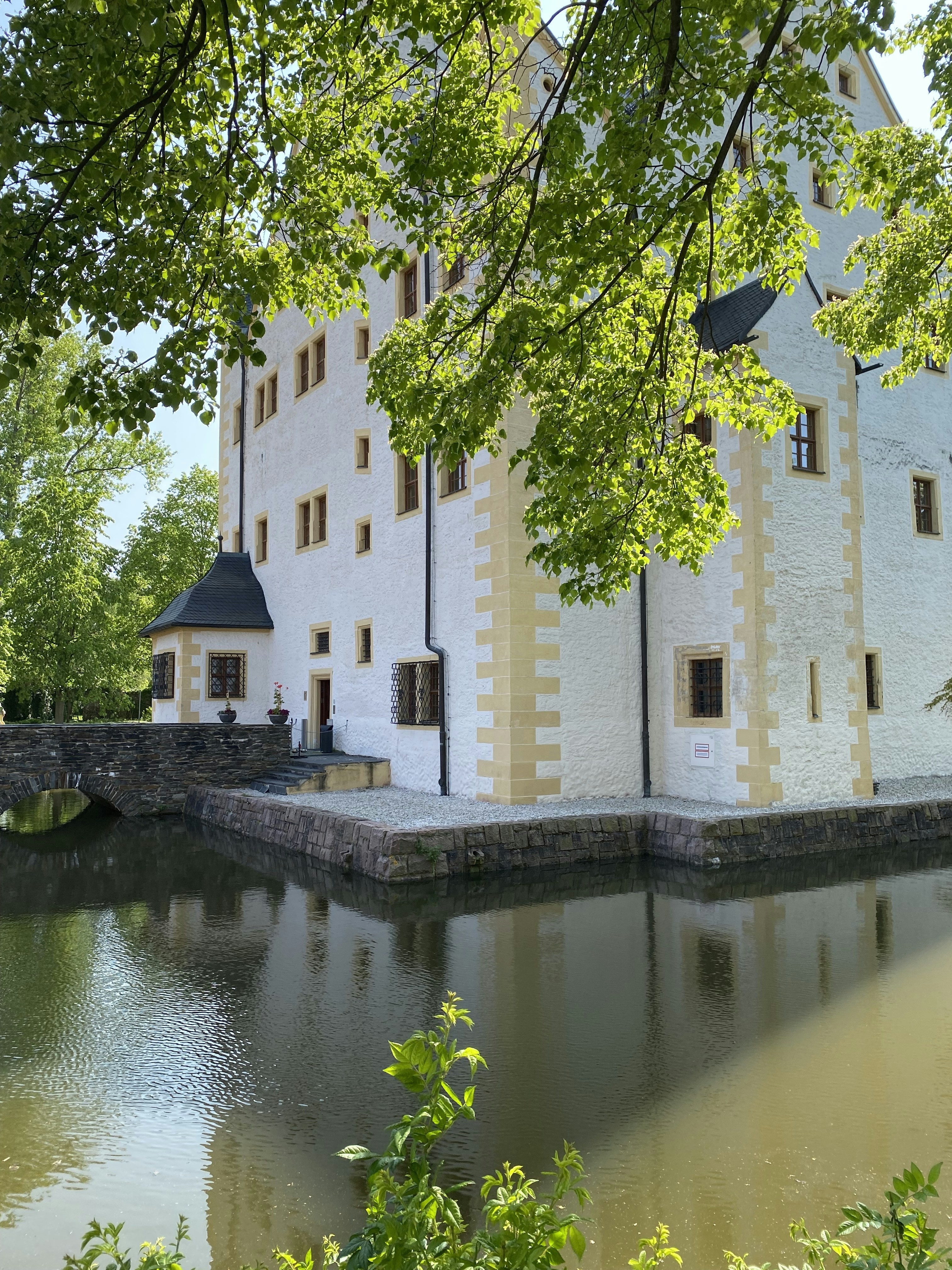 A large white building sitting next to a river photo – Free Building ...