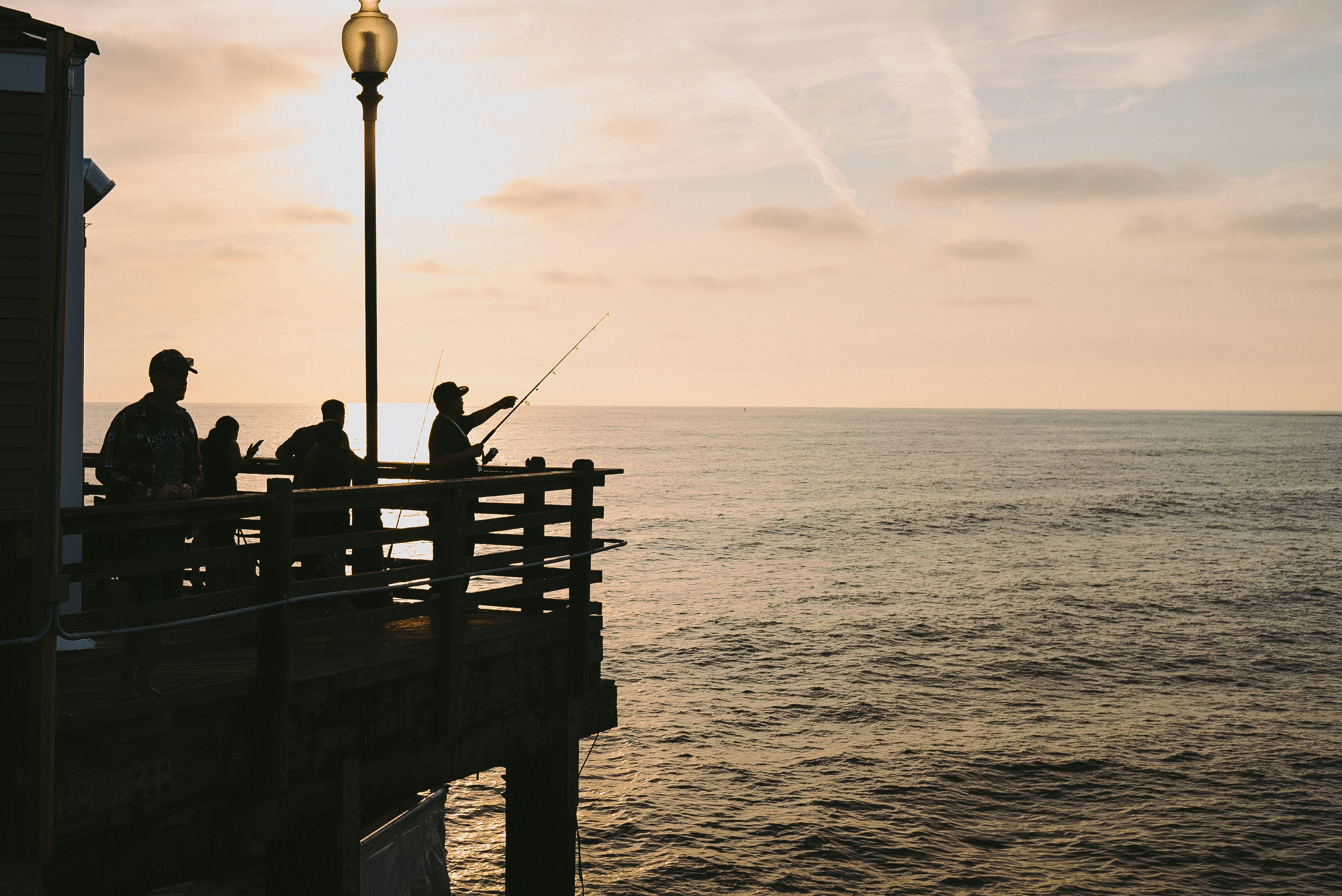 Evening Cast from the Pier: Silhouettes and a Calm Horizon