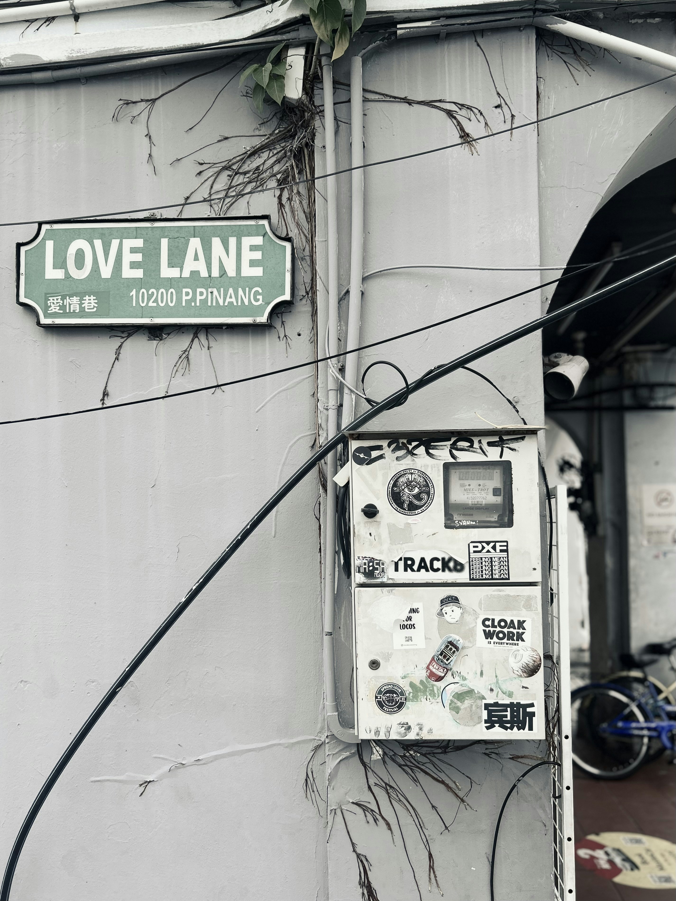Love Lane Graffiti and Utility Box at the Edge of an Urban Wall
