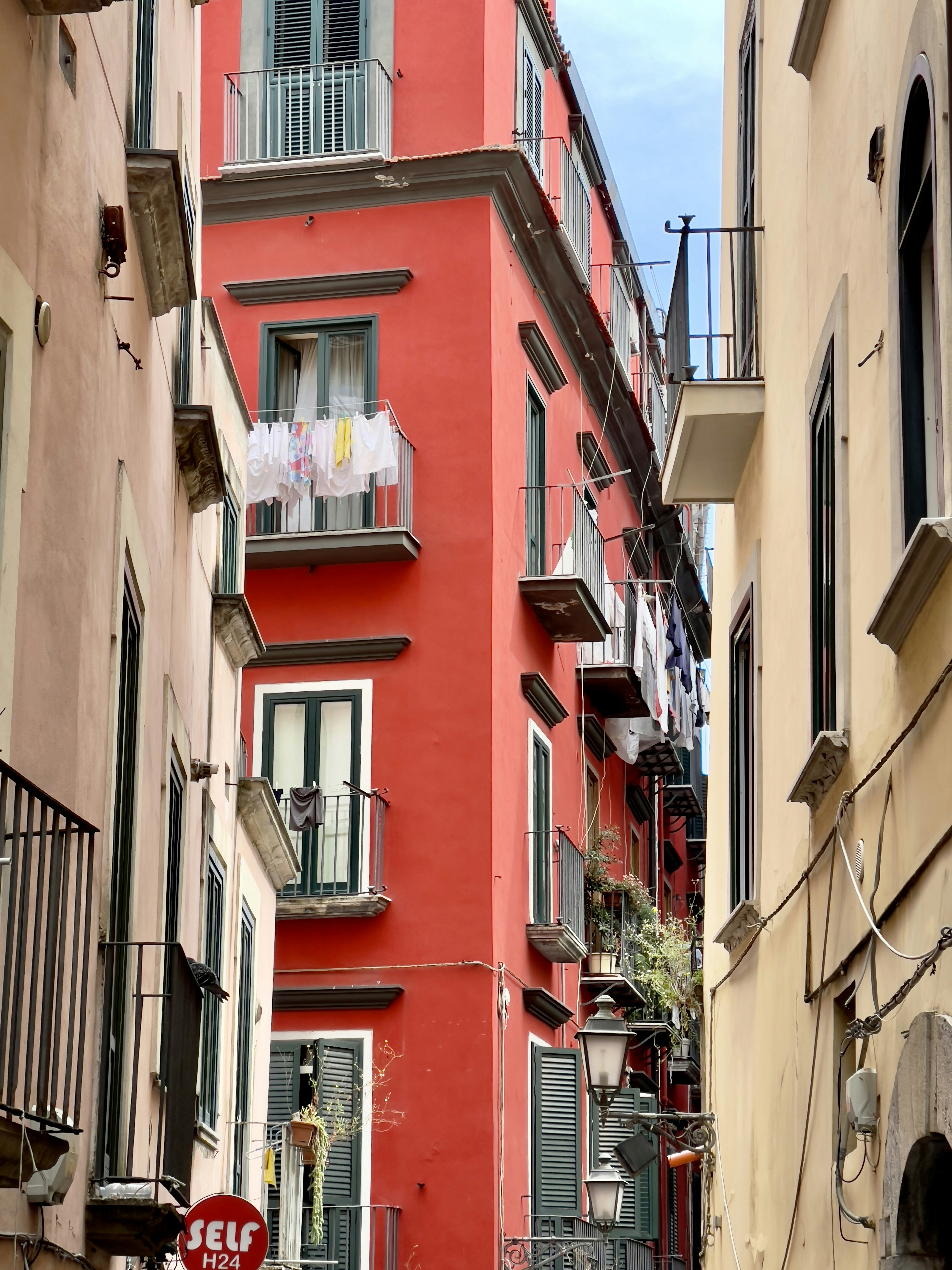 A red building with balconies and balconies on the balconies photo ...