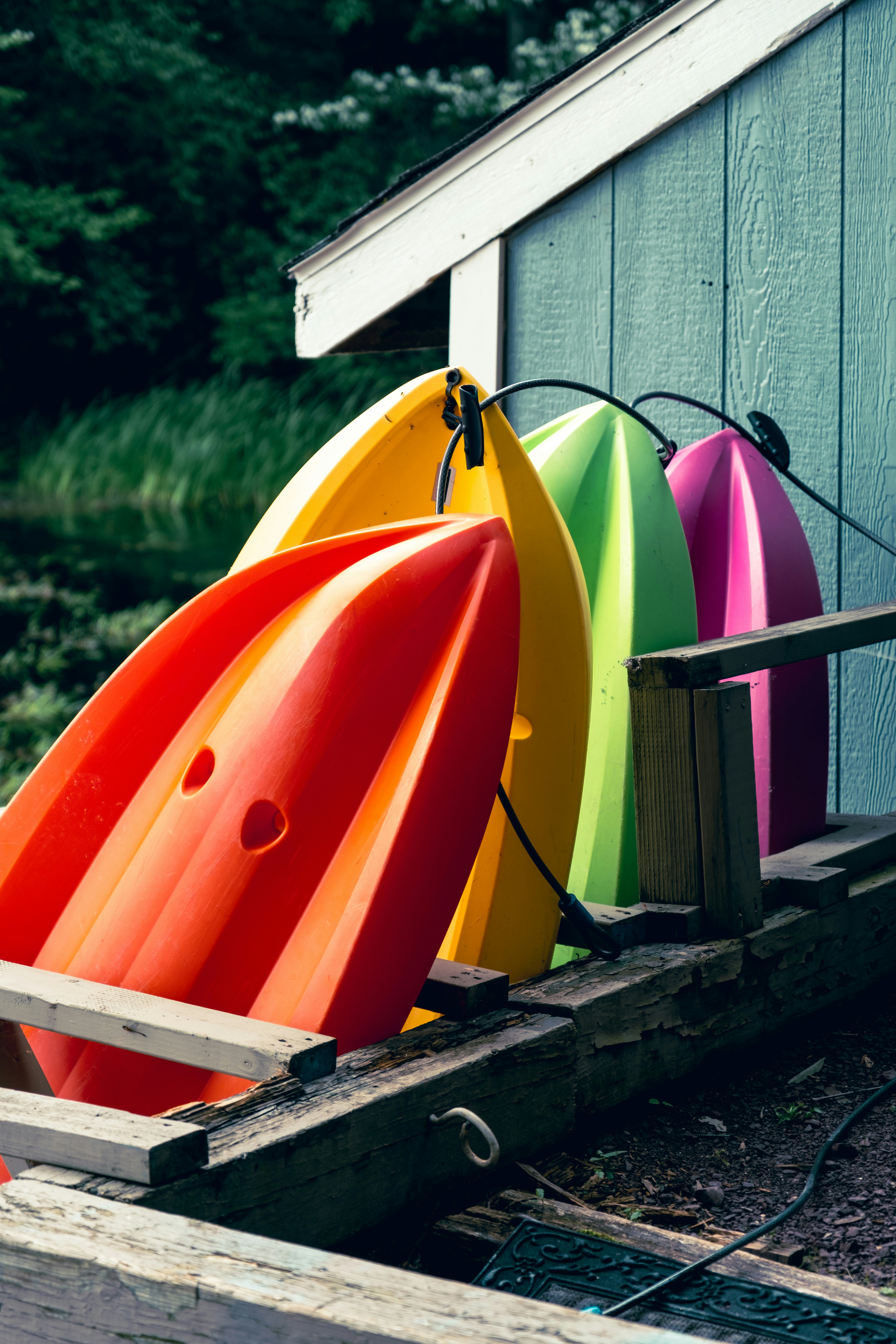 A row of brightly colored surfboards sitting on a wooden platform photo ...