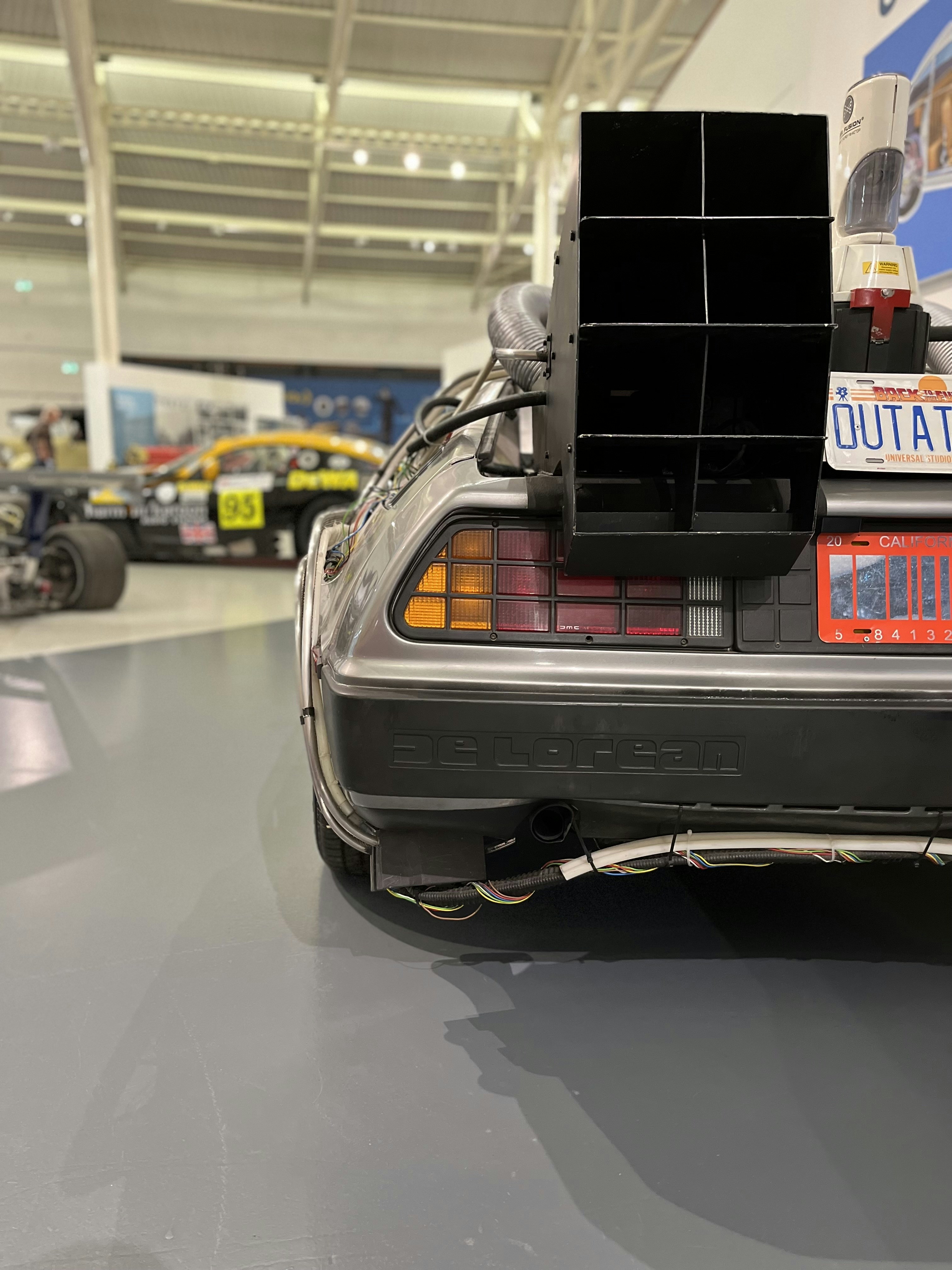 A back view of a car in a showroom photo – Free Wallpaper Image on Unsplash