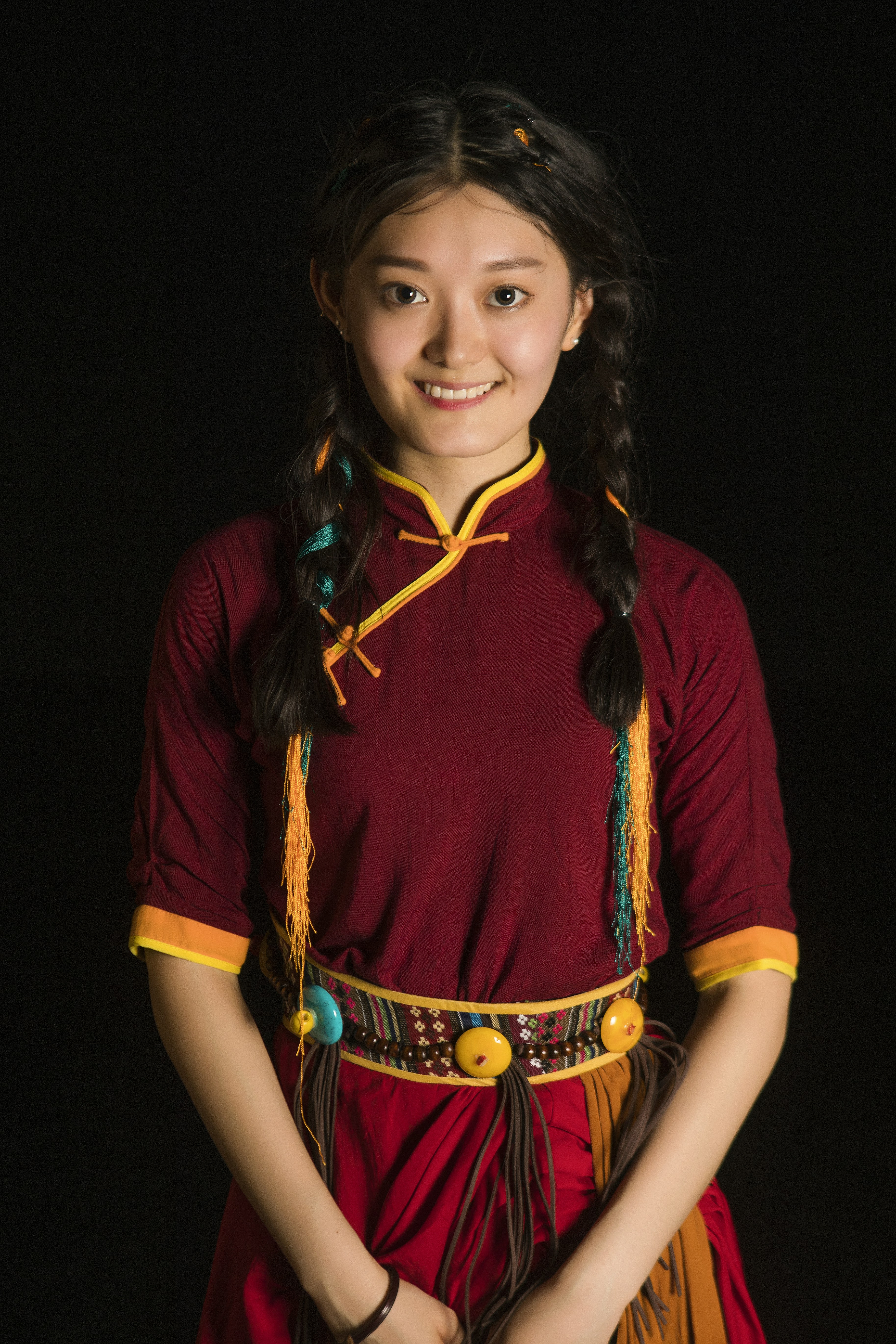 Crimson Silk Portrait: Braids, Belt Beads, and Quiet Studio Light
