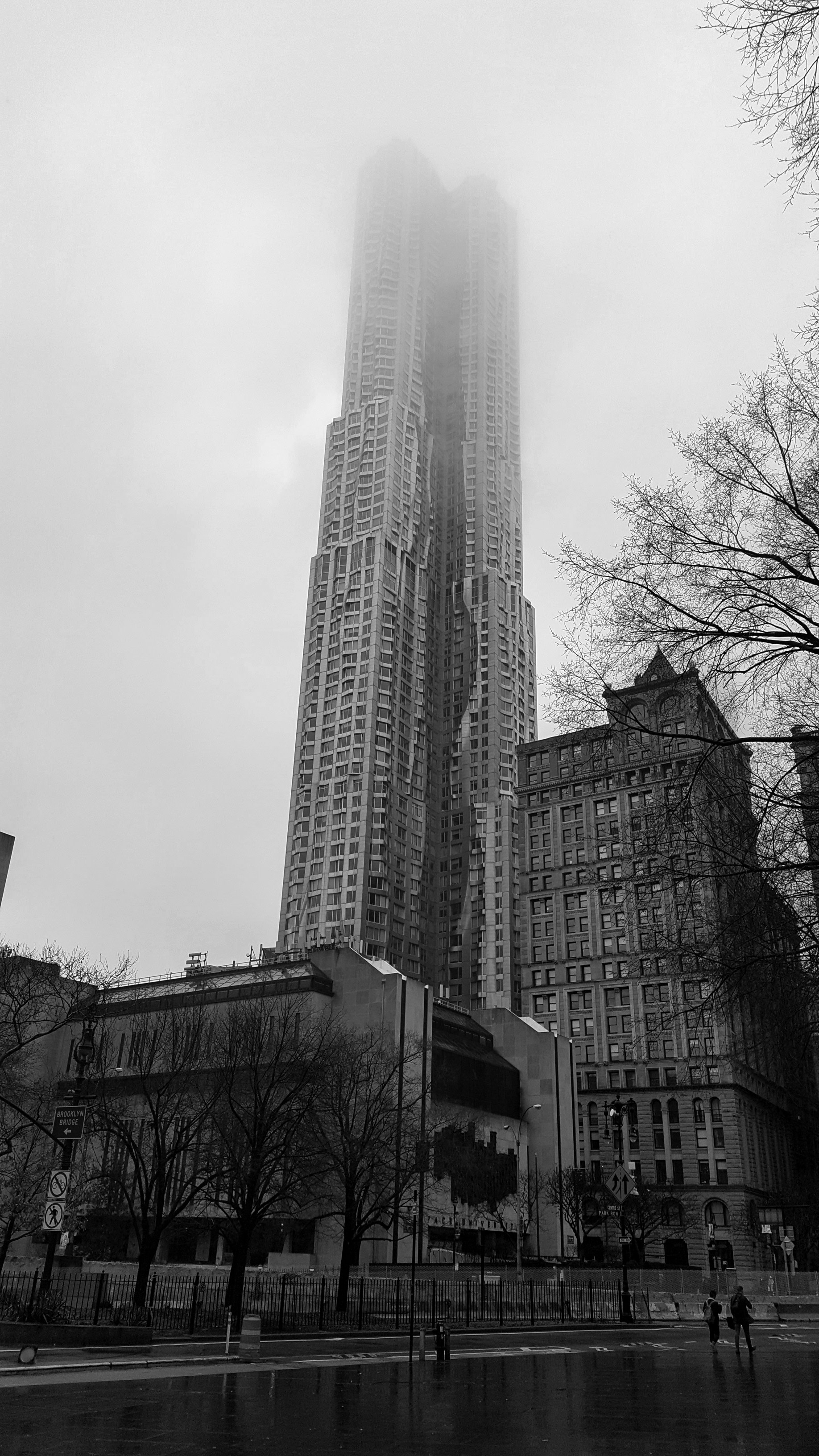 A very tall building towering over a city photo – Free New york Image ...