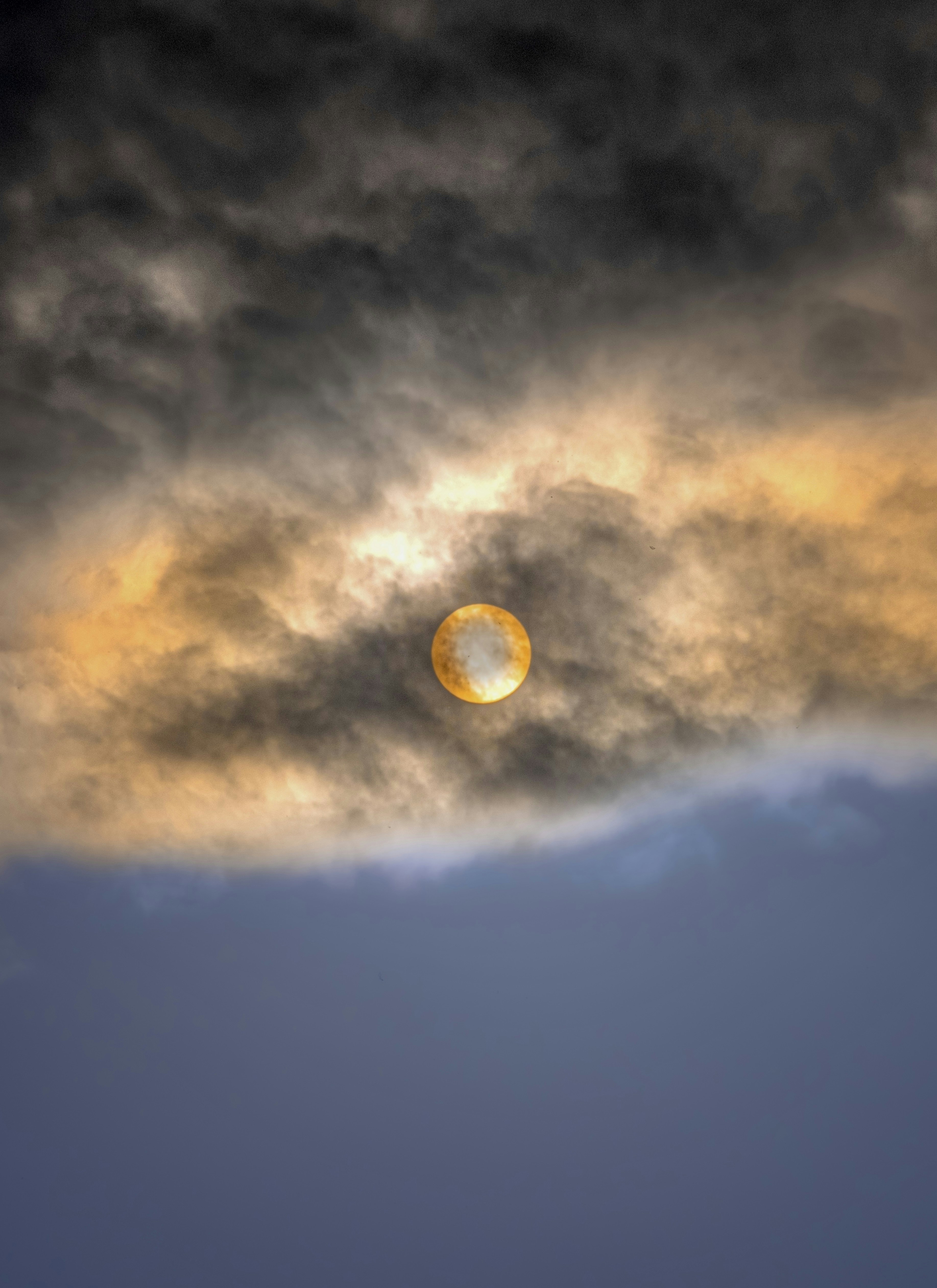 Ember Orb Piercing a Cloudscape of Ash and Sky