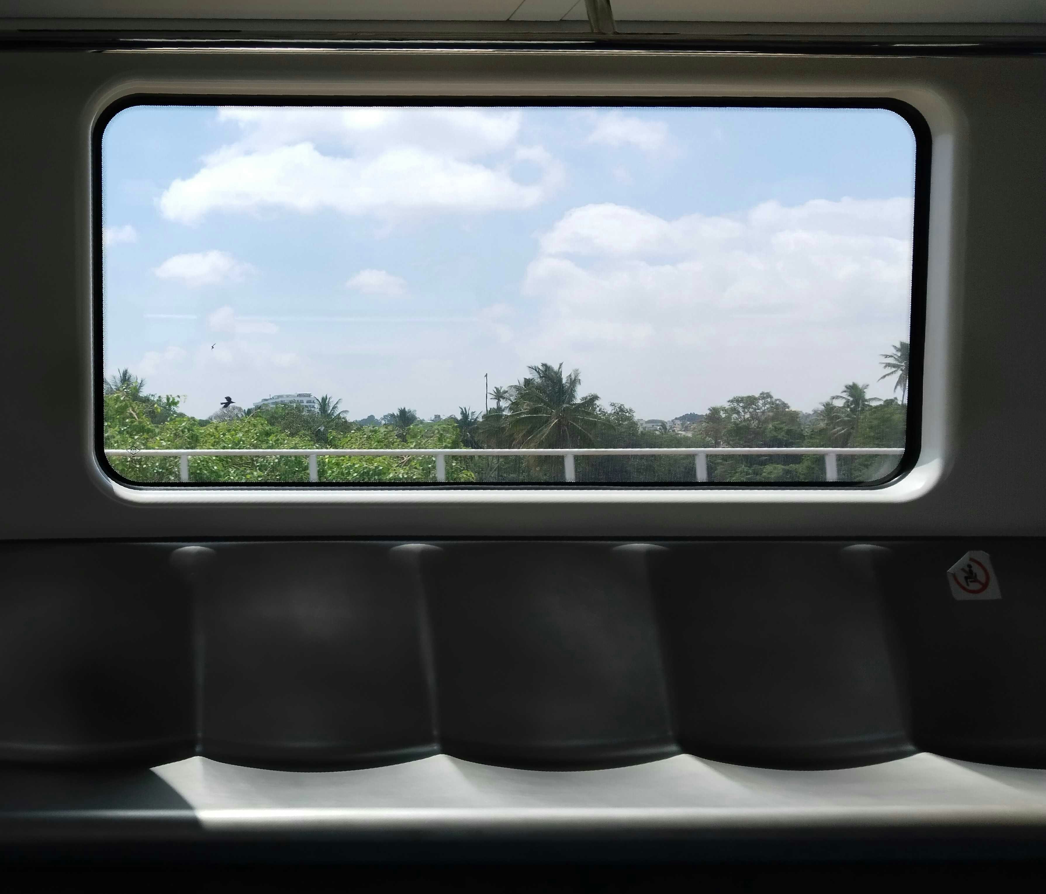 A window on a train with a view of trees photo – Free India Image on ...