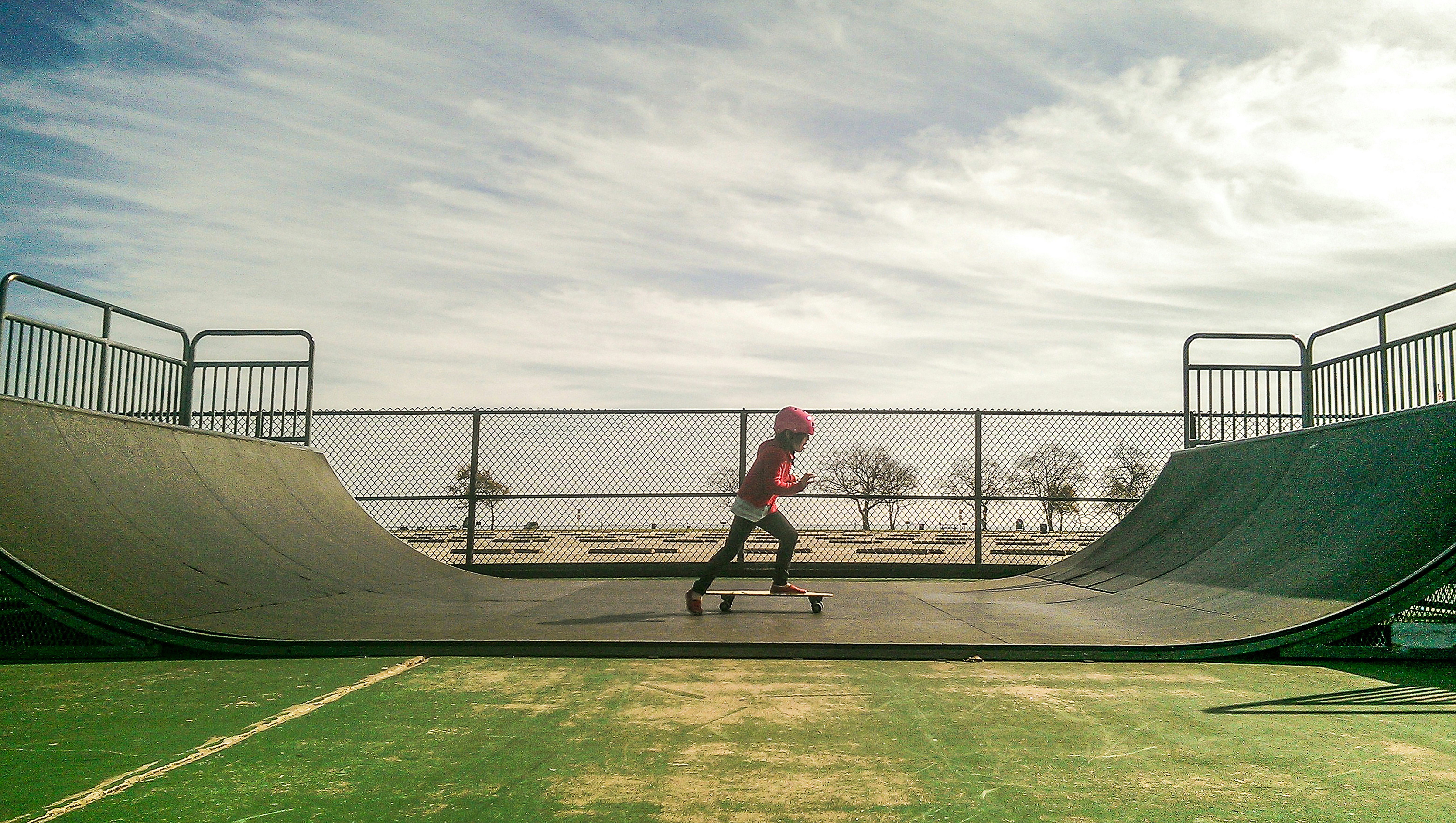 A man riding a skateboard up the side of a ramp photo – Free Beach ...