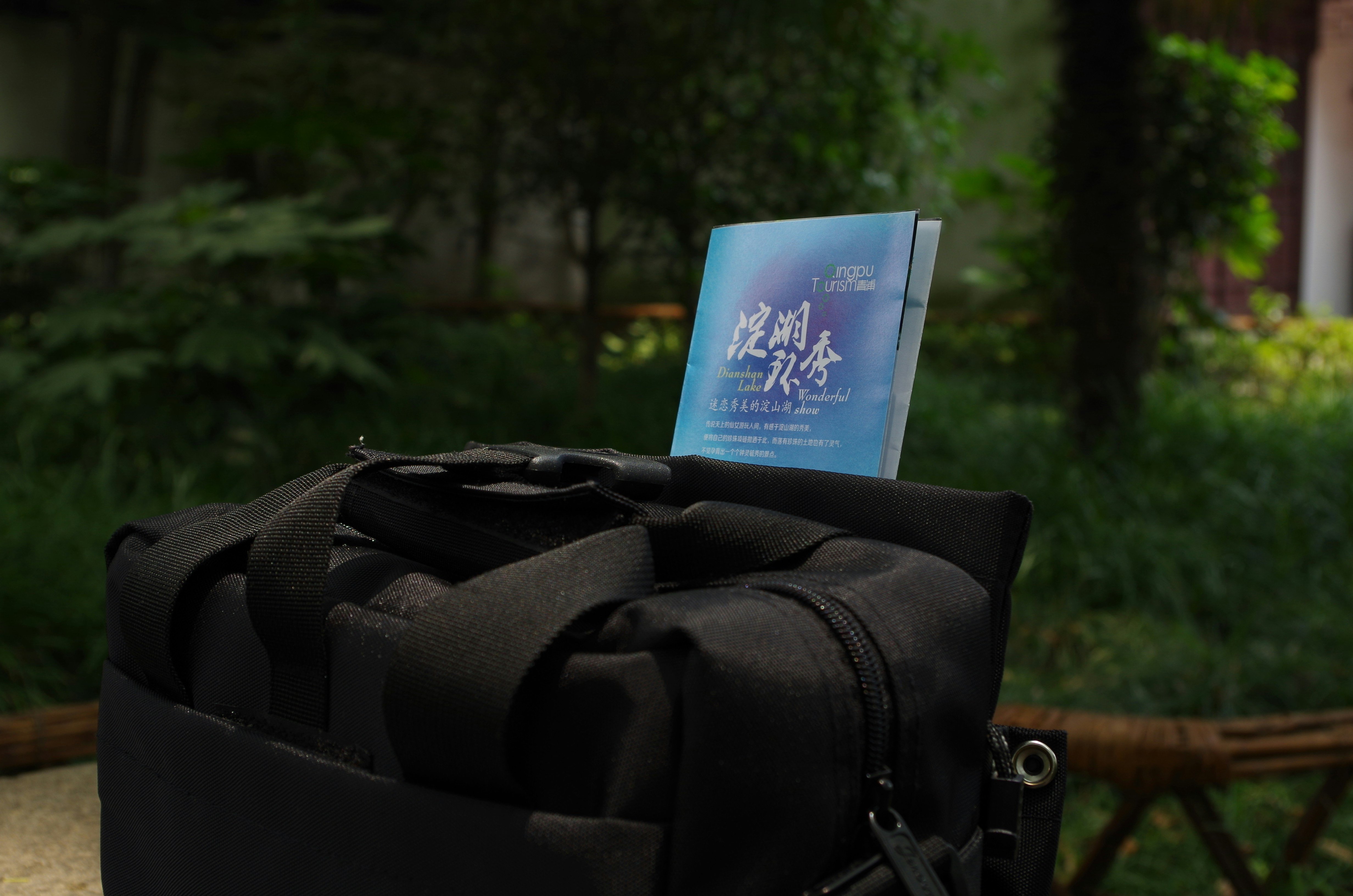 a book sitting on top of a black bag