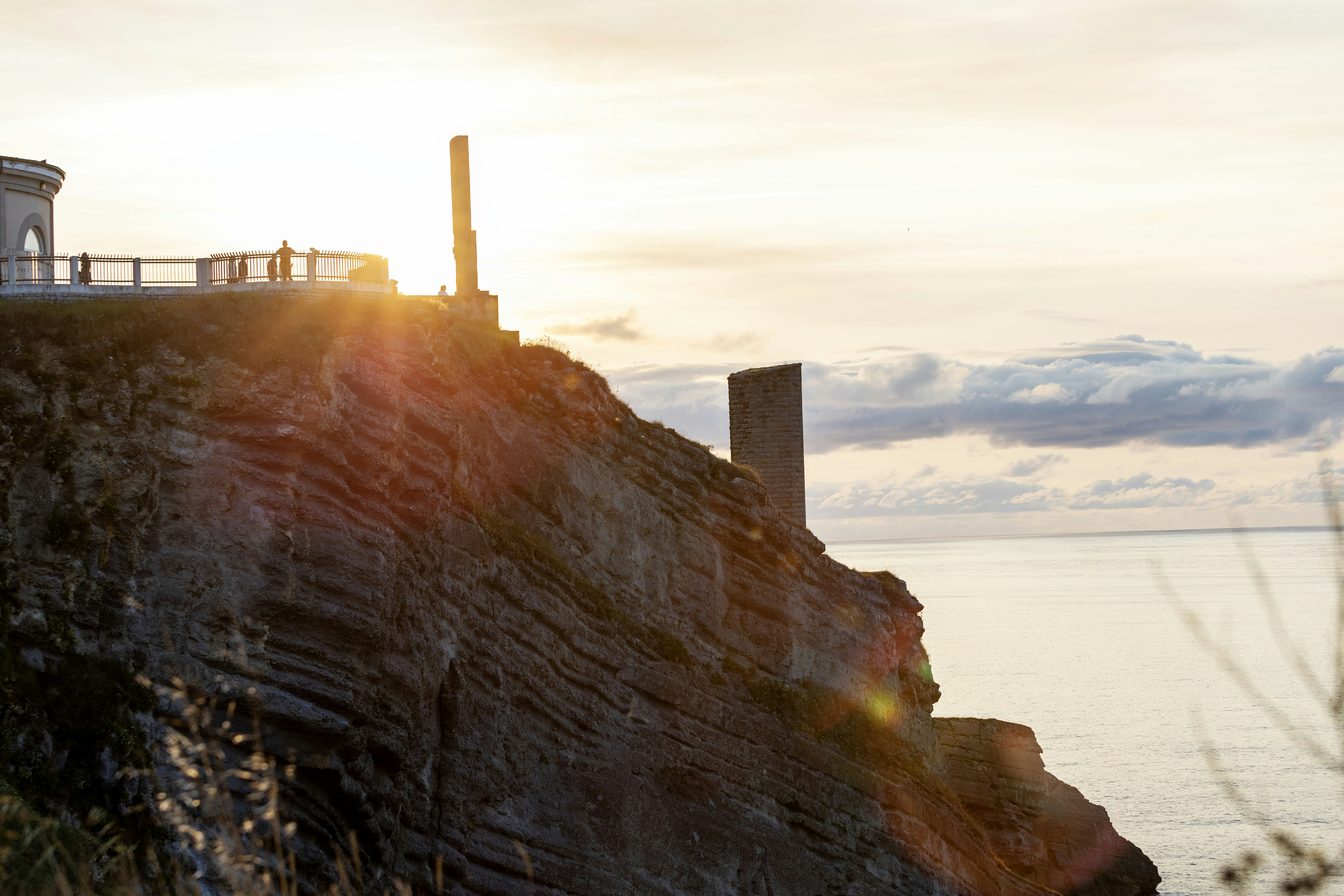 Sunlit Cloffs and Cliffside Promenade at Dusk