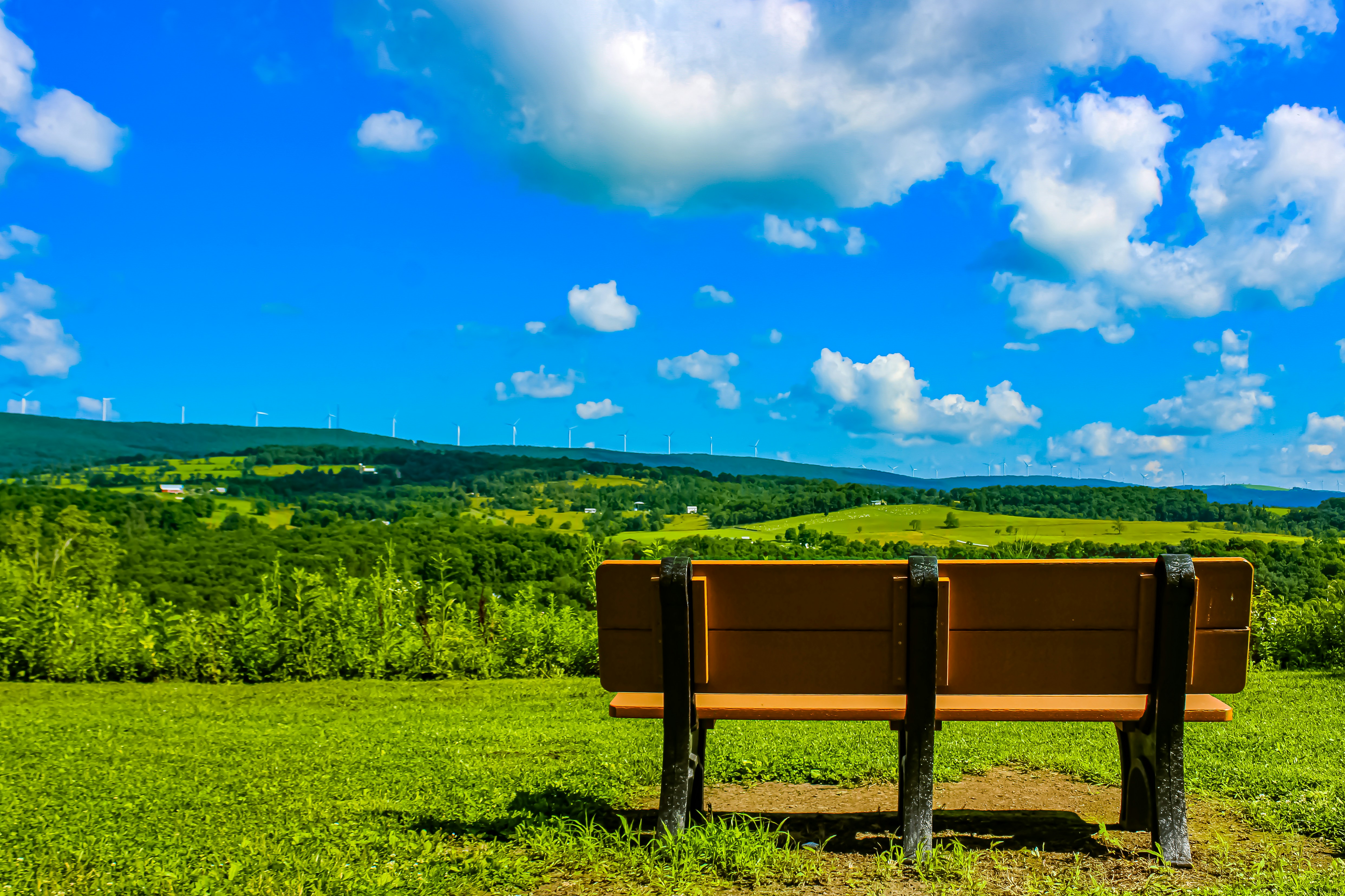 Bench Beside the Hill: Wind Turbines and a Cerulean Sky