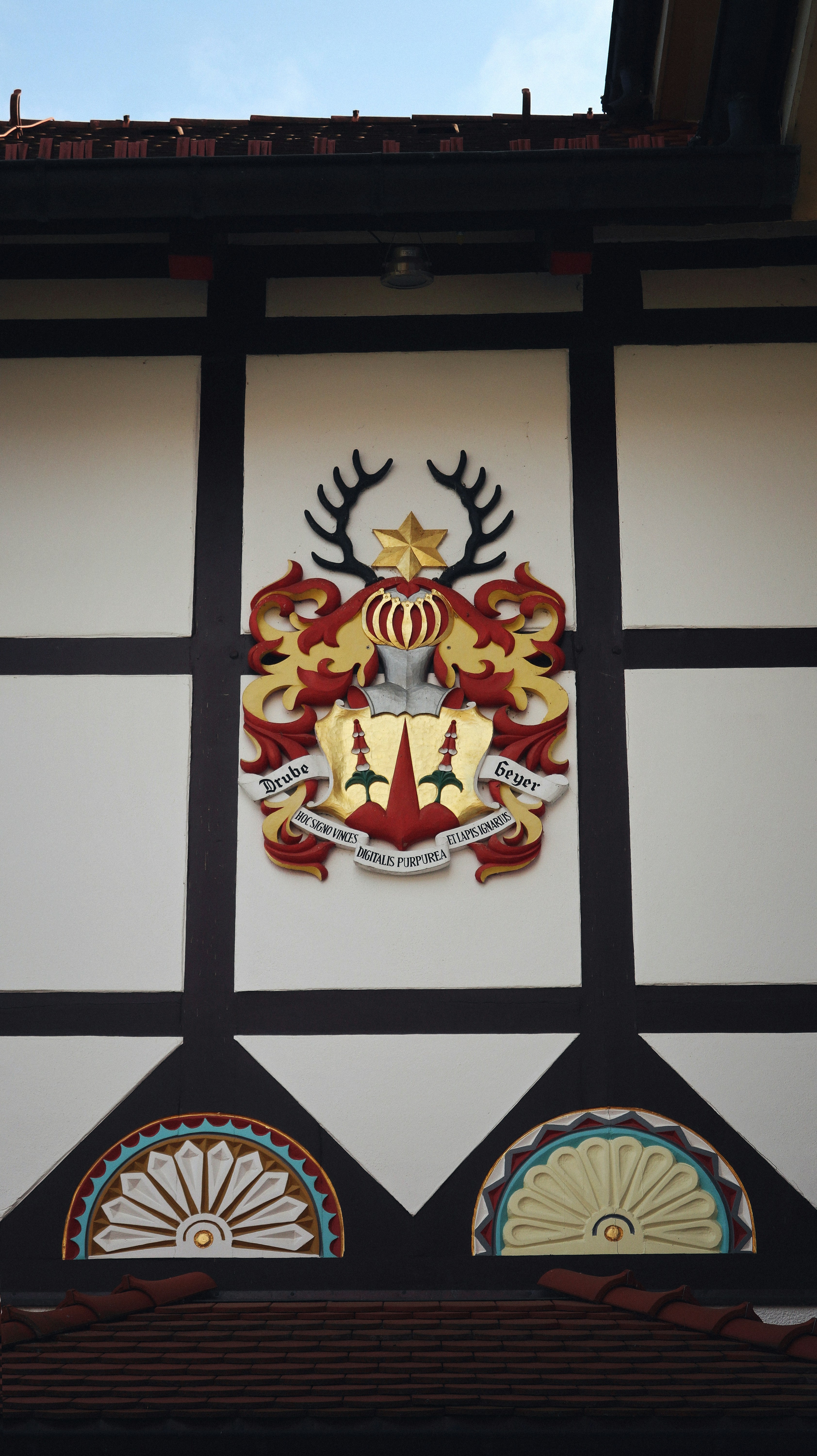 Heraldic Crest in a Timber-Framed Façade: Crowned Antlers Over a Shield