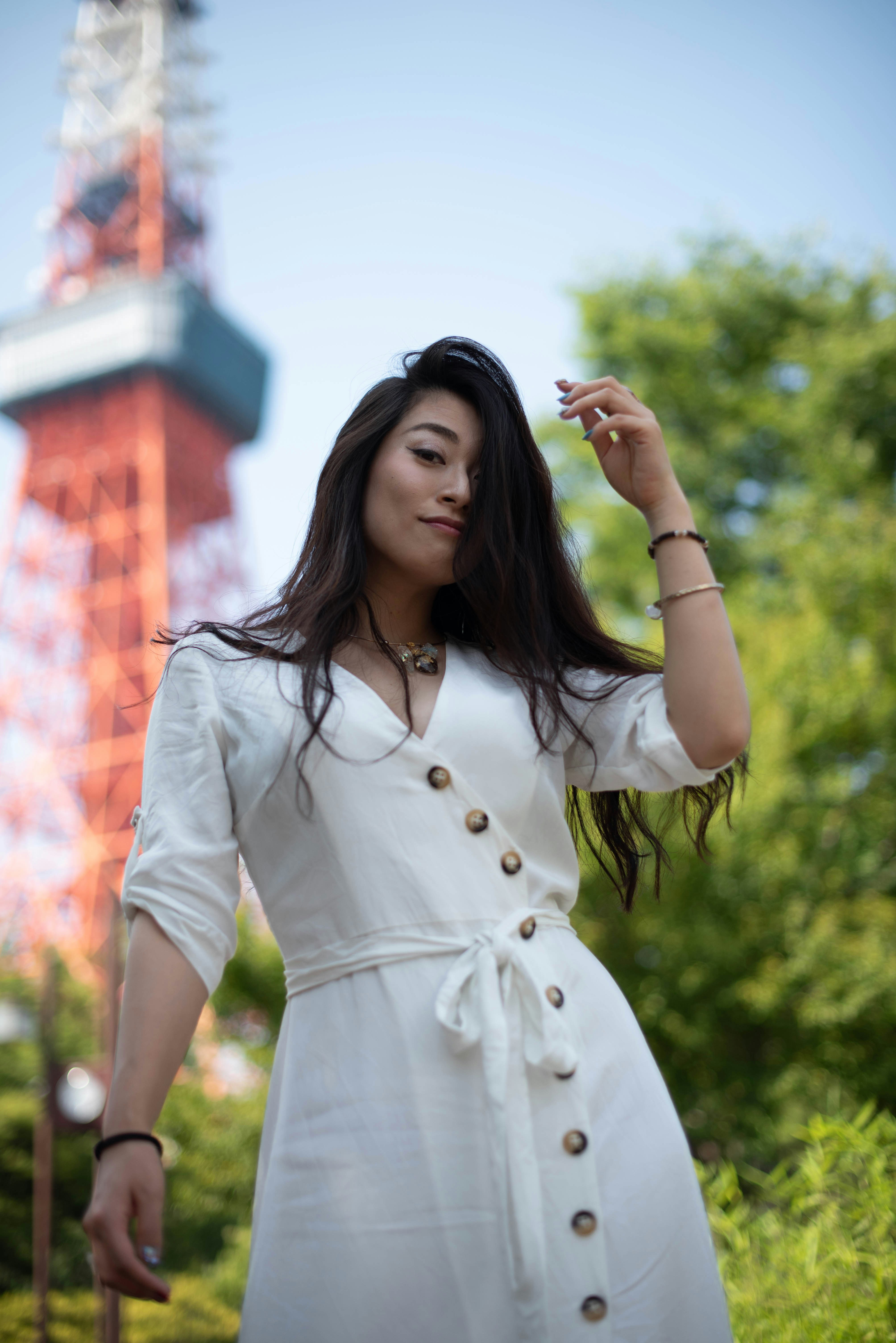 White Dress in Bloom: Portrait Beneath a Bold Skyline