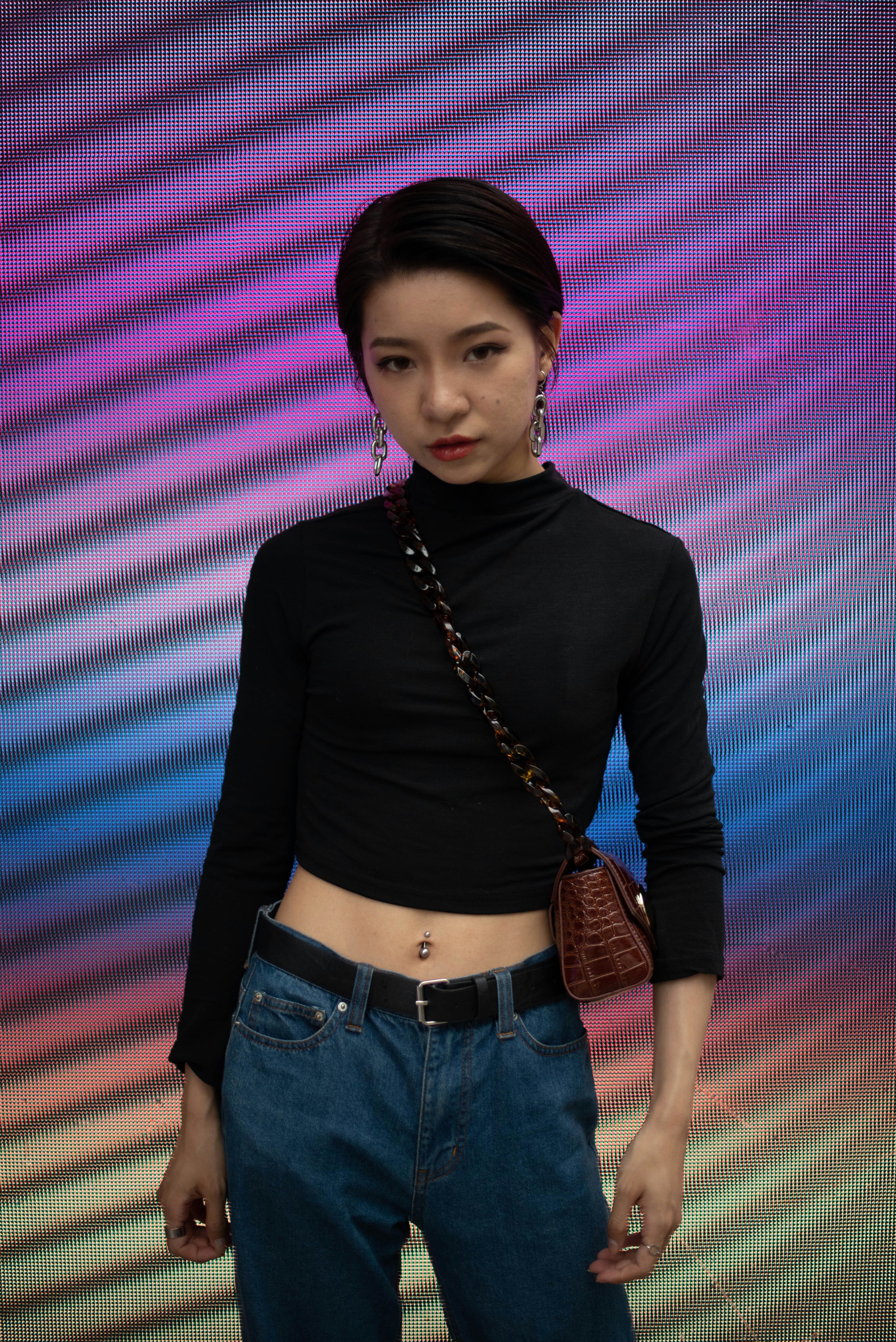 Portrait on a Neon Gradient Stage: Confident Presence Before an LED Backdrop