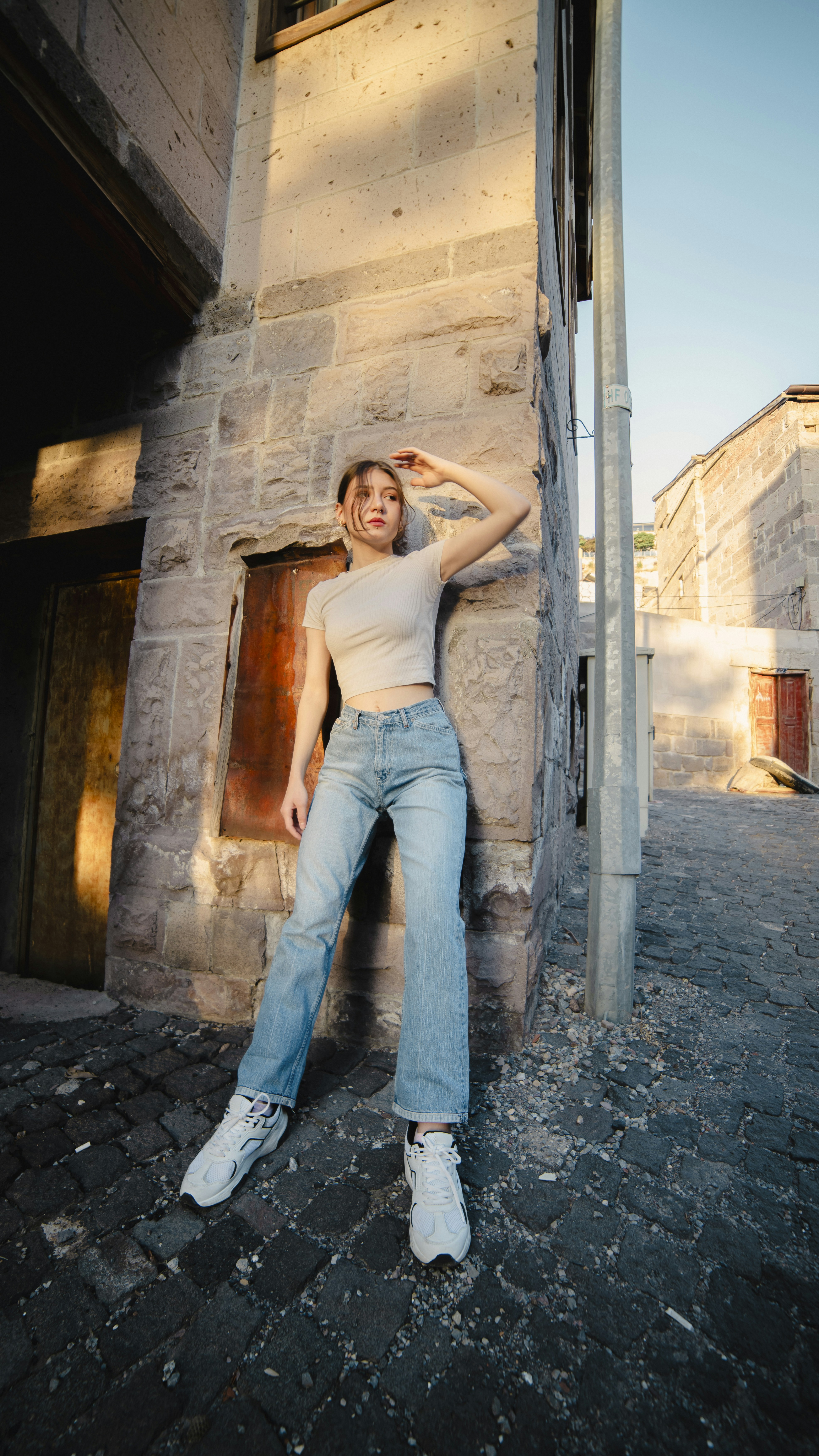A woman posing for a picture in front of a building photo – Free Talas ...