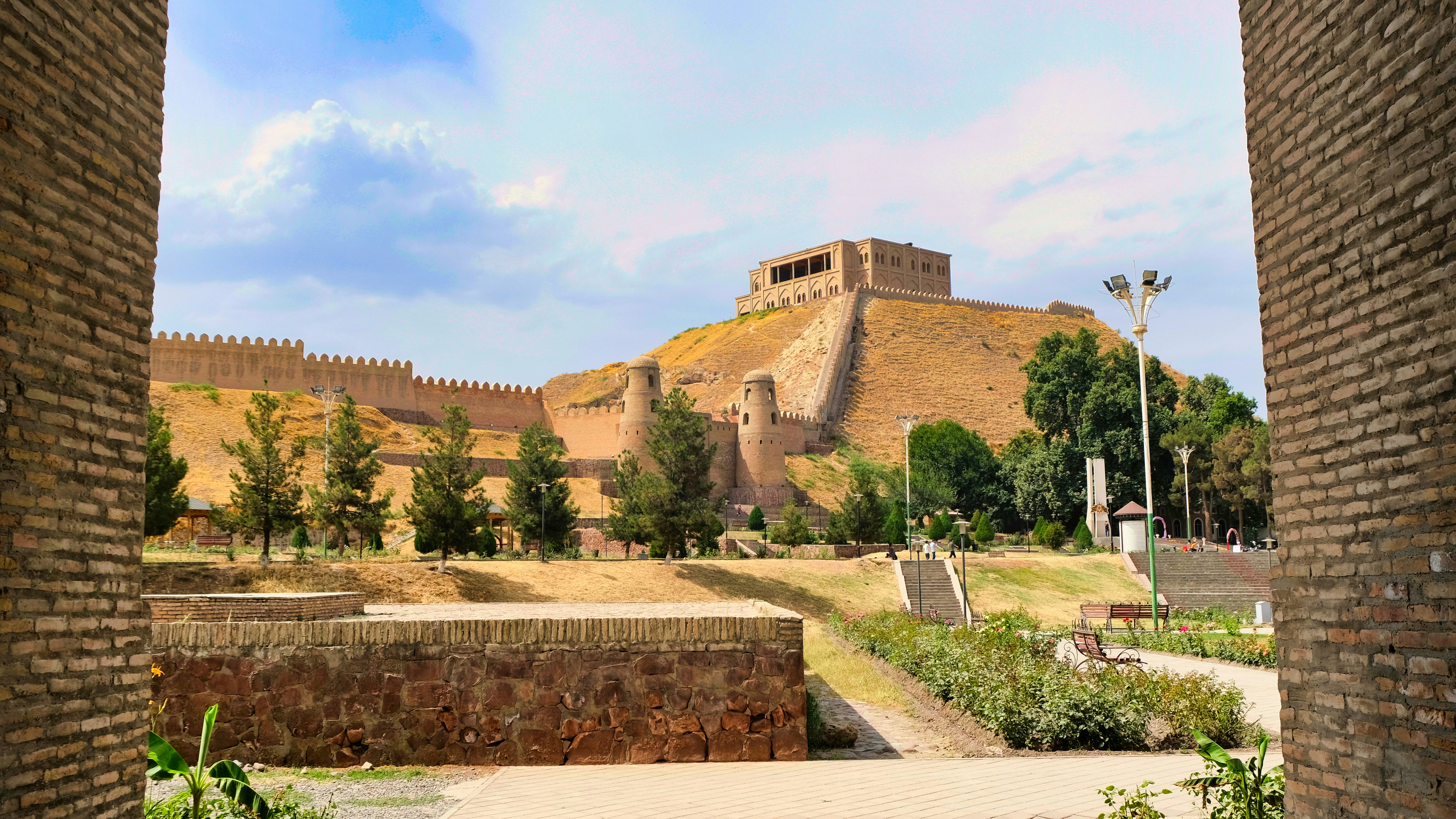 A view of a castle through two brick walls photo – Free Gissar Image on ...