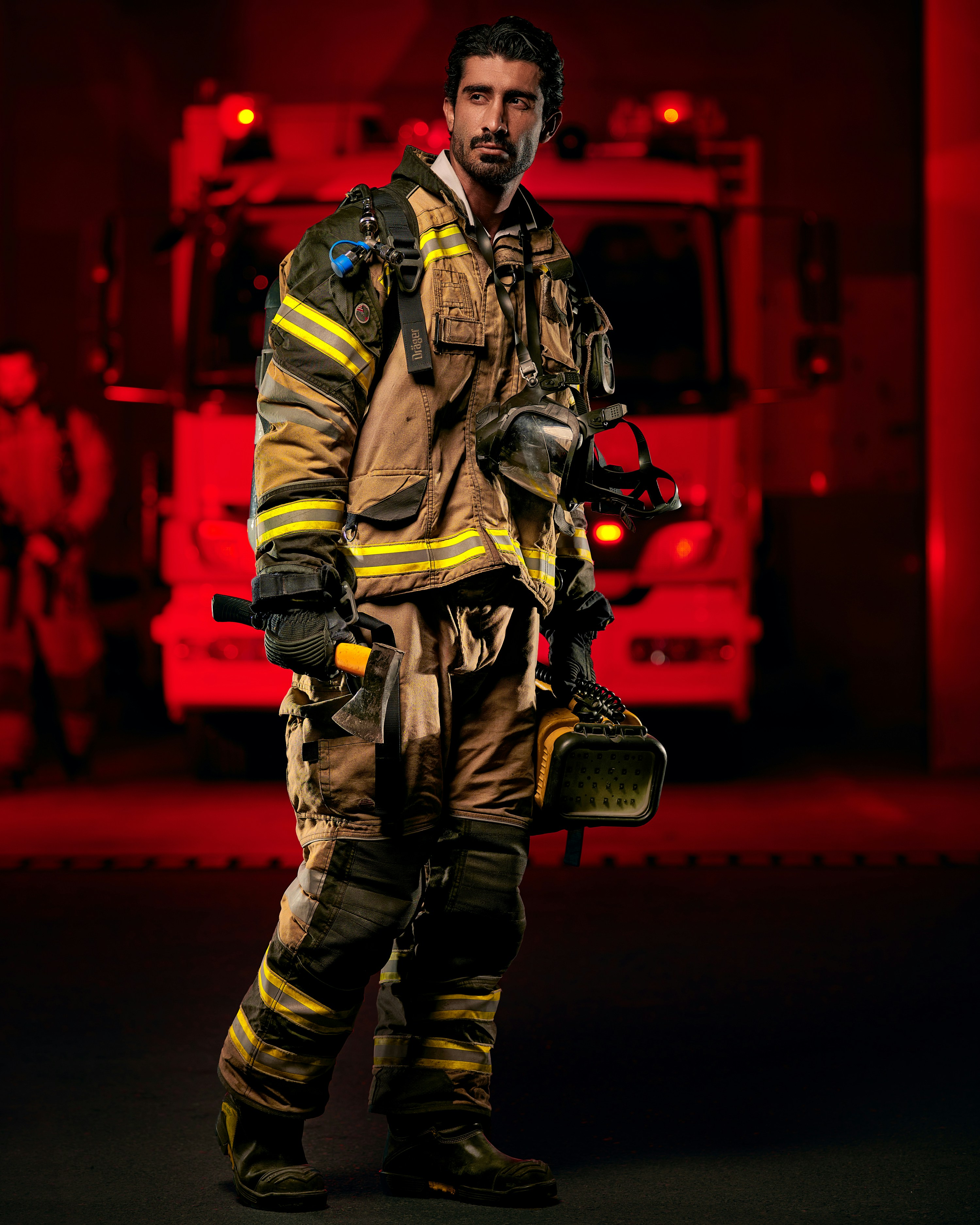 A firefighter standing in front of a fire truck photo – Free Creative ...