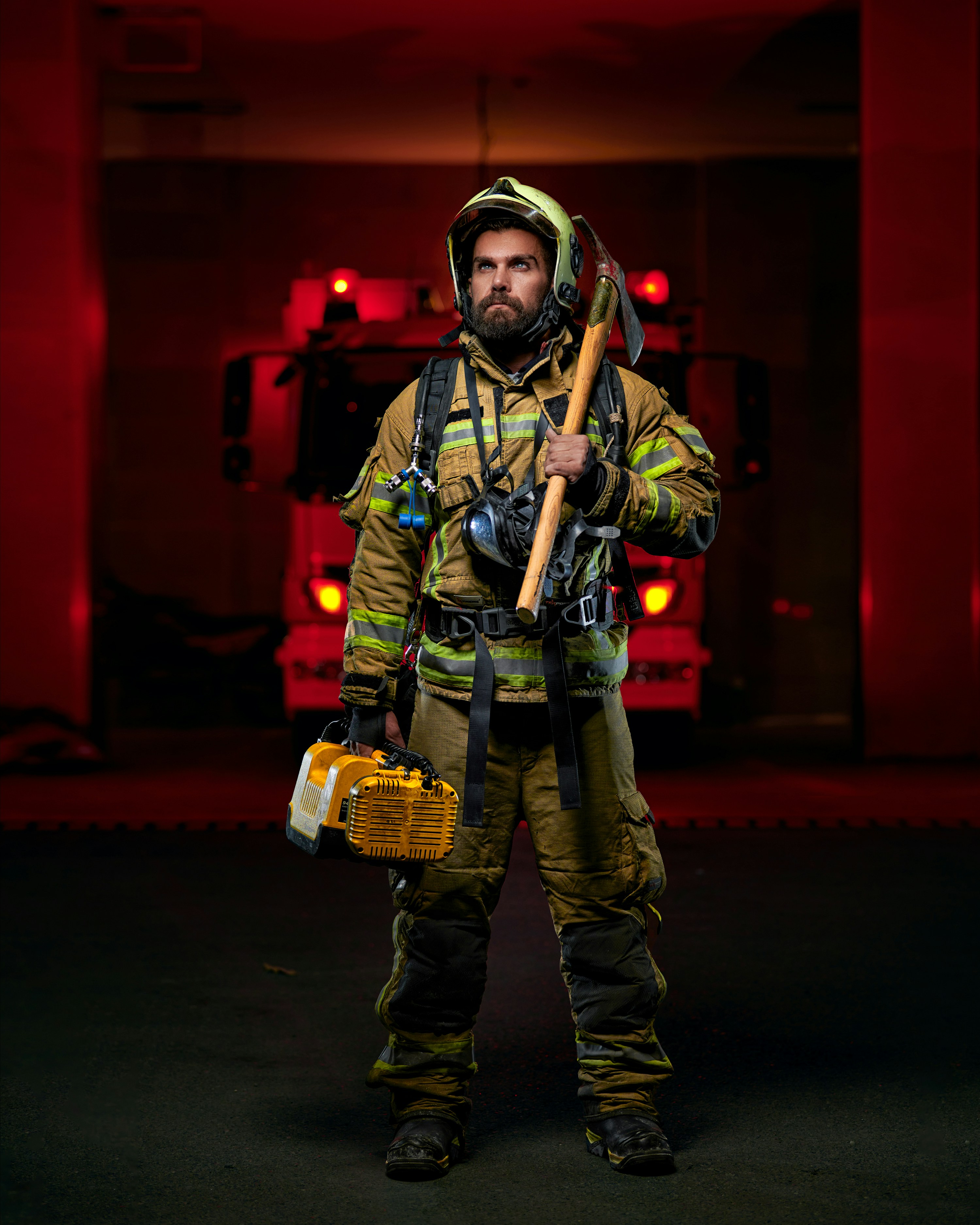 A man in a firefighter's uniform holding a fire extinguisher photo ...