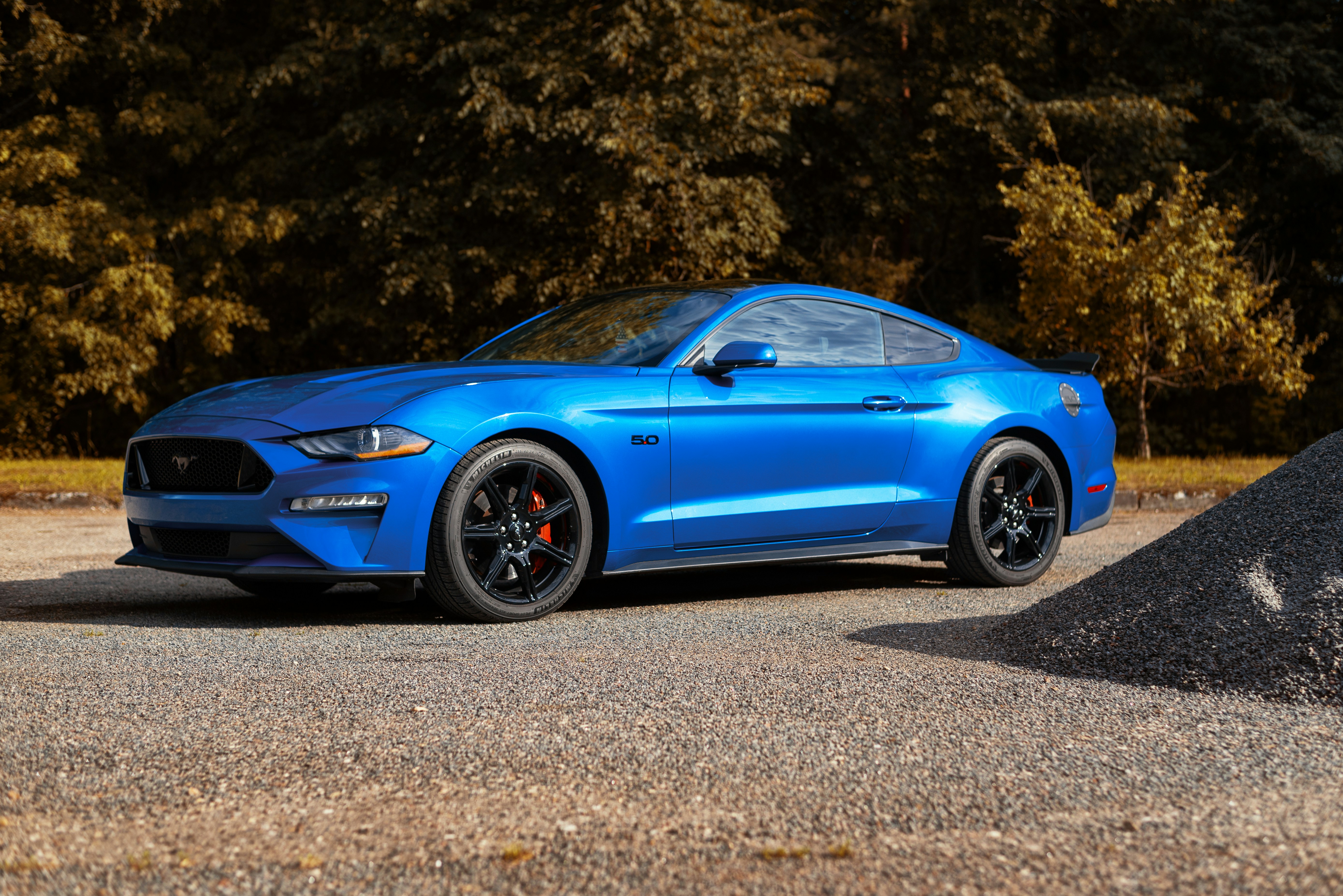 A blue ford mustang parked in a parking lot photo – Free Minsk Image on ...
