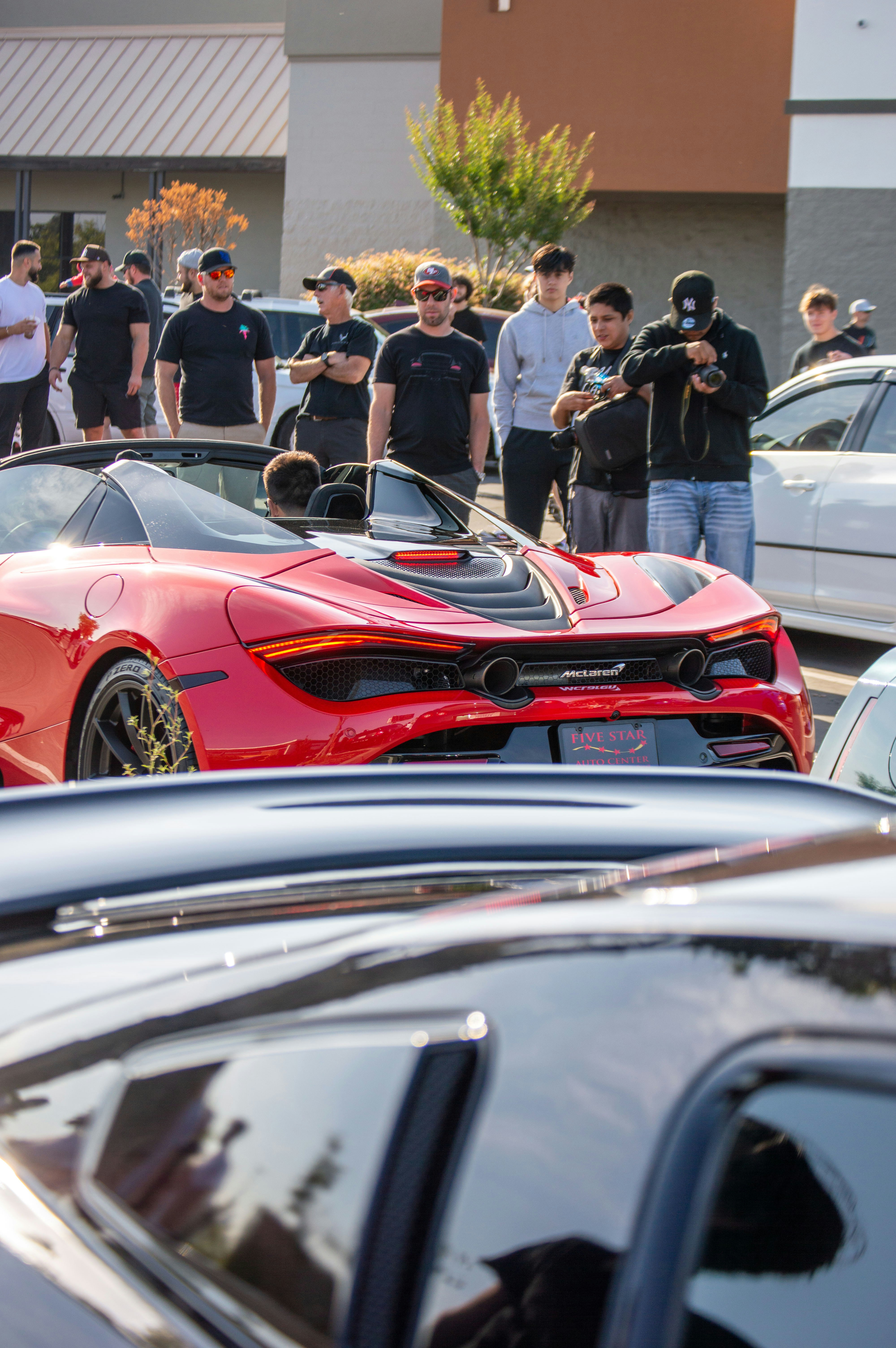 Crimson Veloce at a Street Car Meet: Red Ferrari Surrounded by Enthusiasts