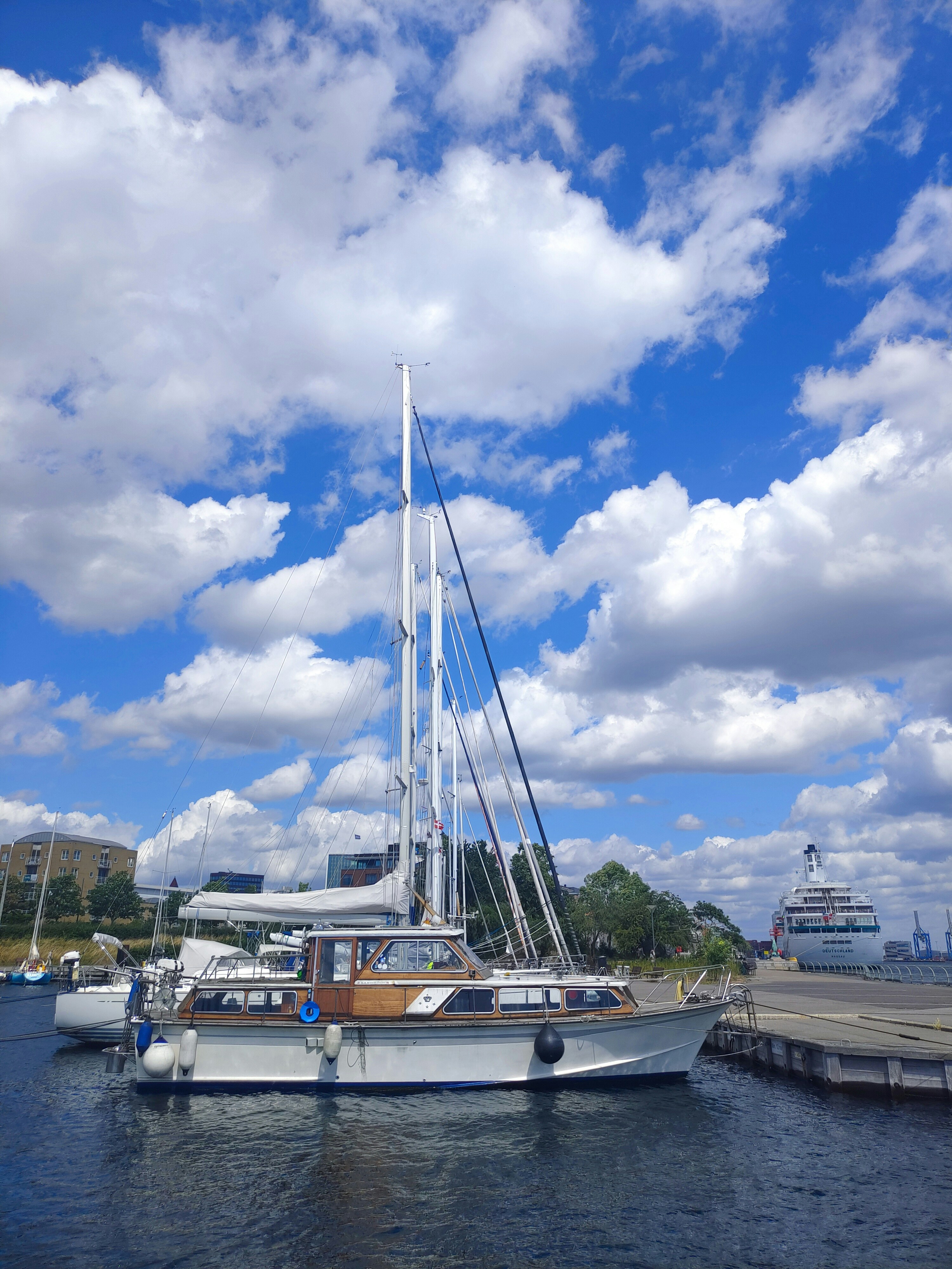 A sailboat docked at a dock in a harbor photo – Free Denmark Image on ...