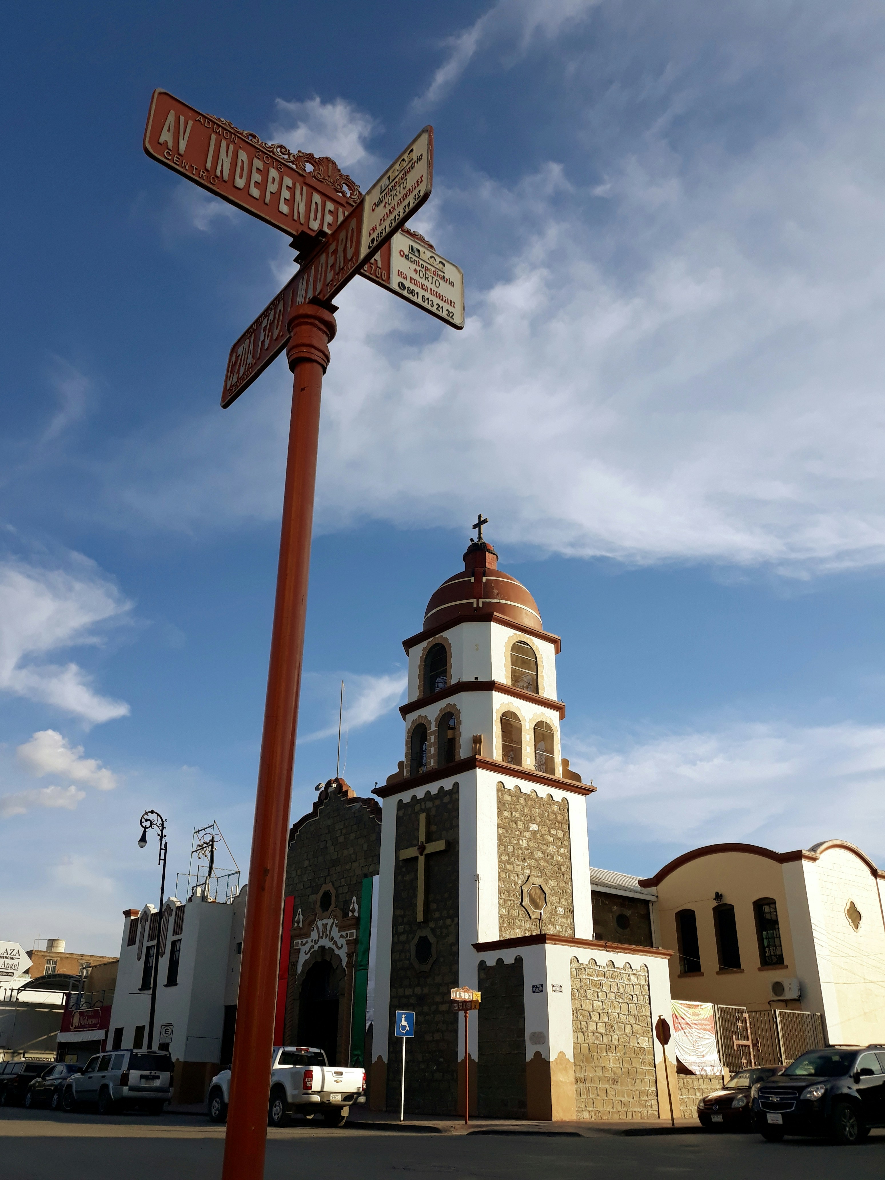 A street sign in front of a church photo – Free Car Image on Unsplash