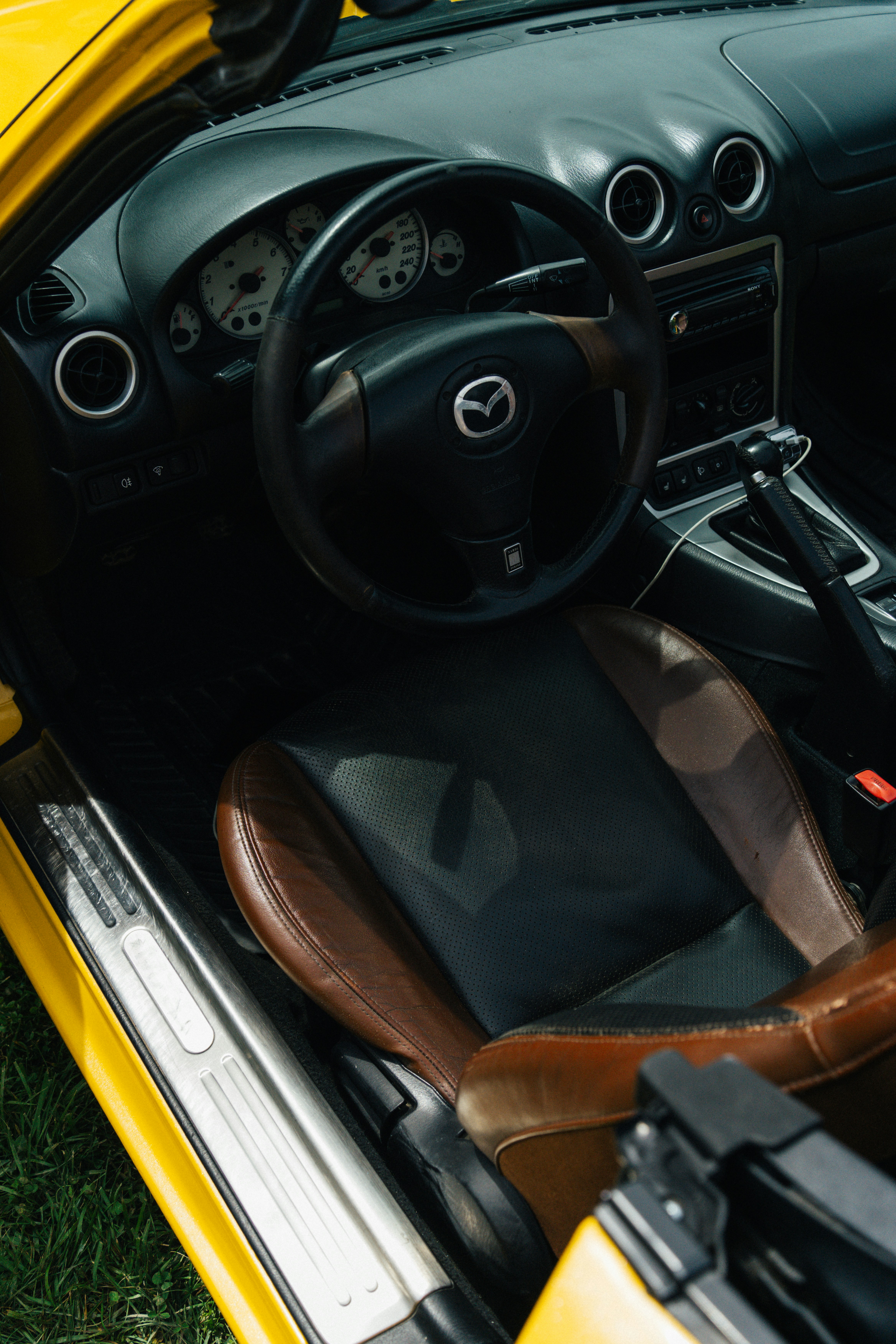 Golden Exterior, Black Dash: A Mazda Cockpit Highlight