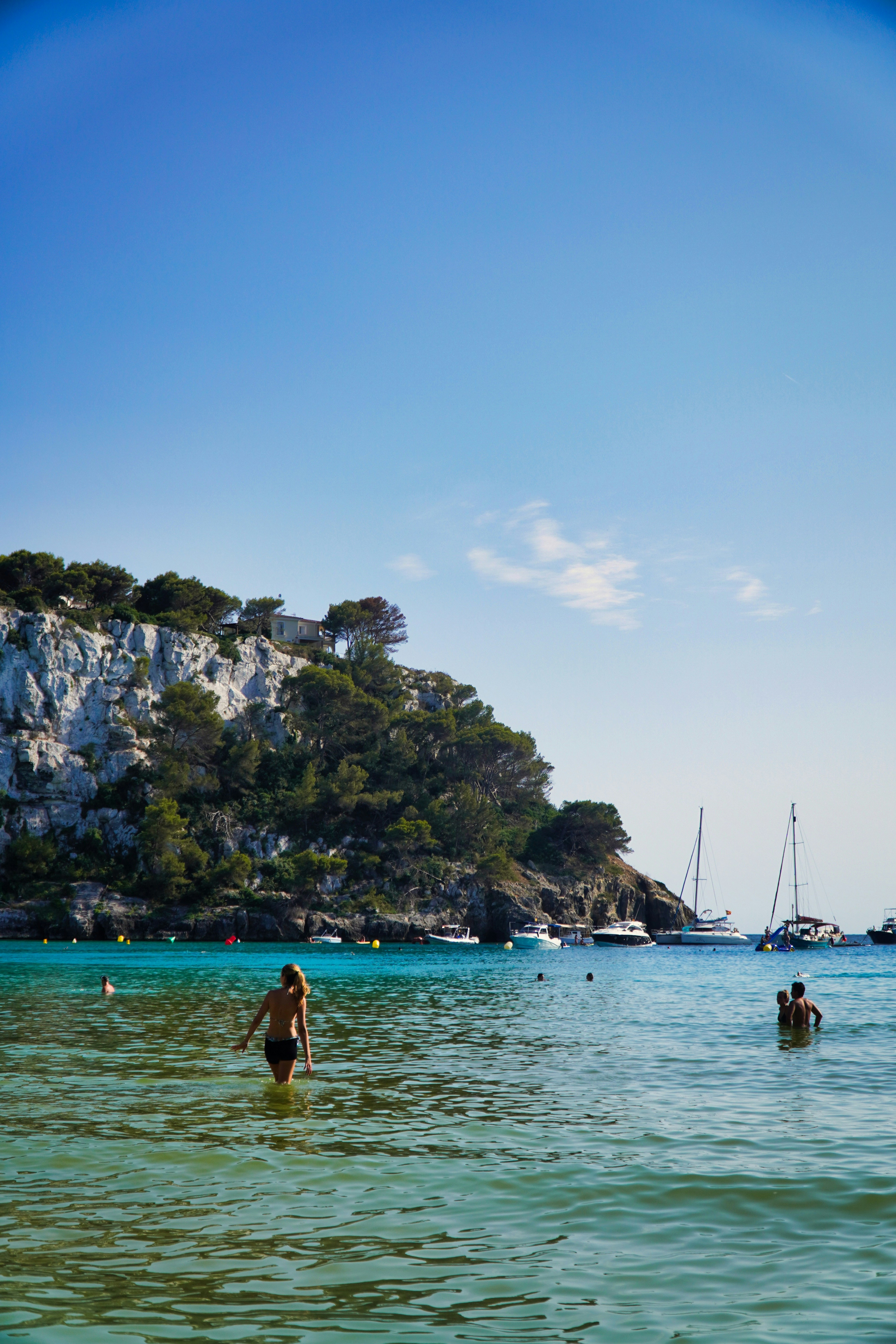 A group of people wading in a body of water photo – Free Beach Image on ...
