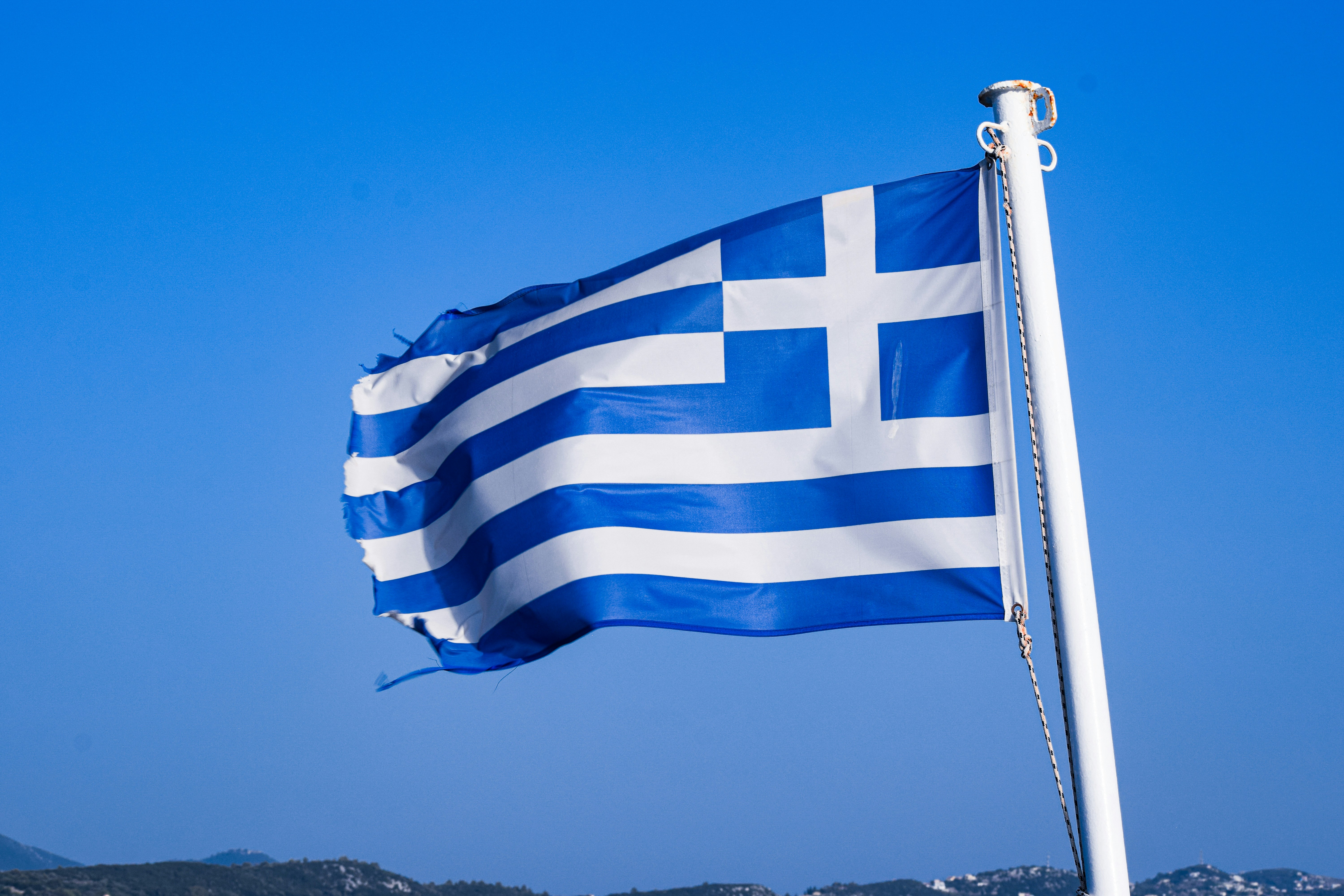 Aegean Wind: The Hellenic Flag Ripples Under a Cerulean Sky