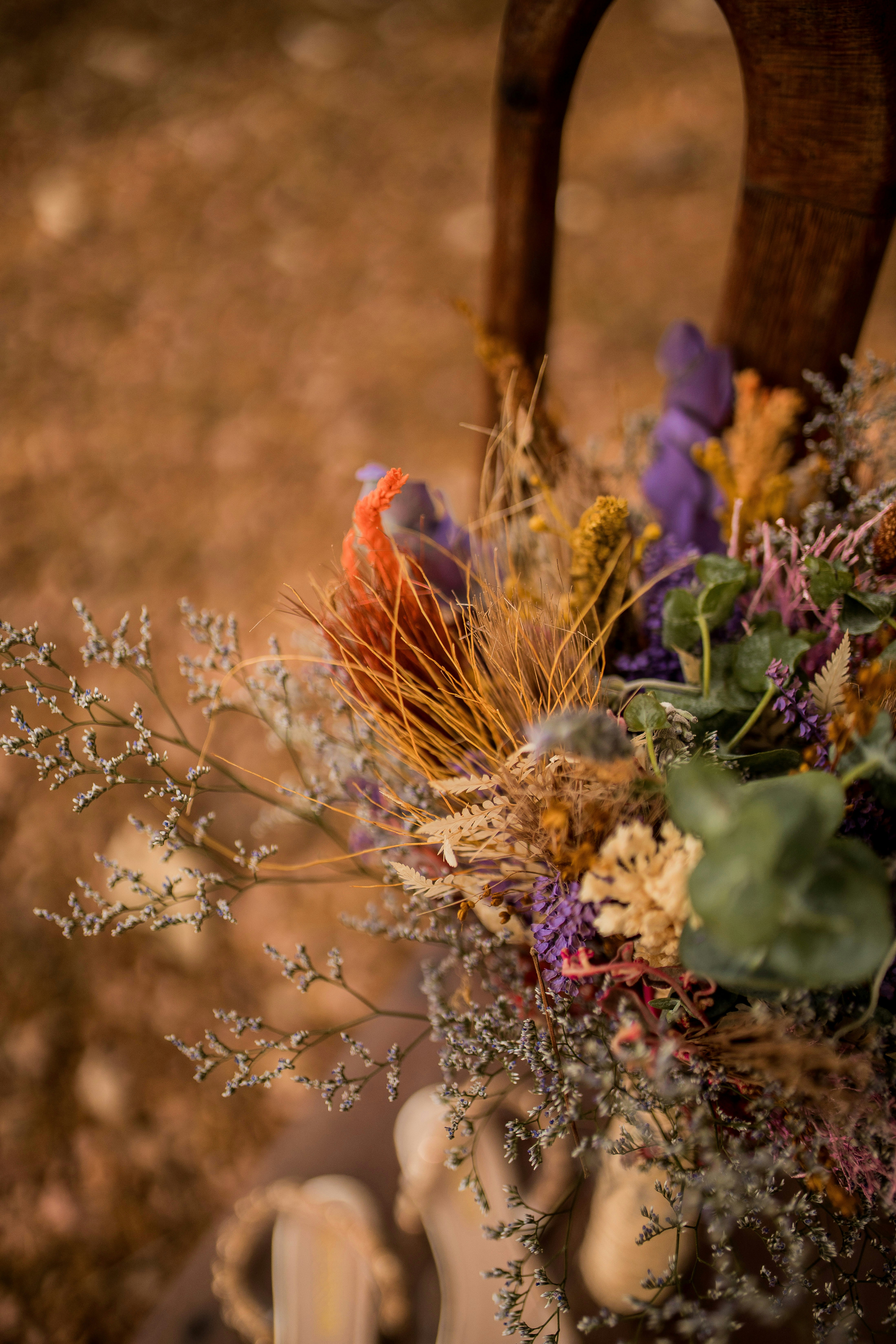 Sunlit bouquet by a weathered chair