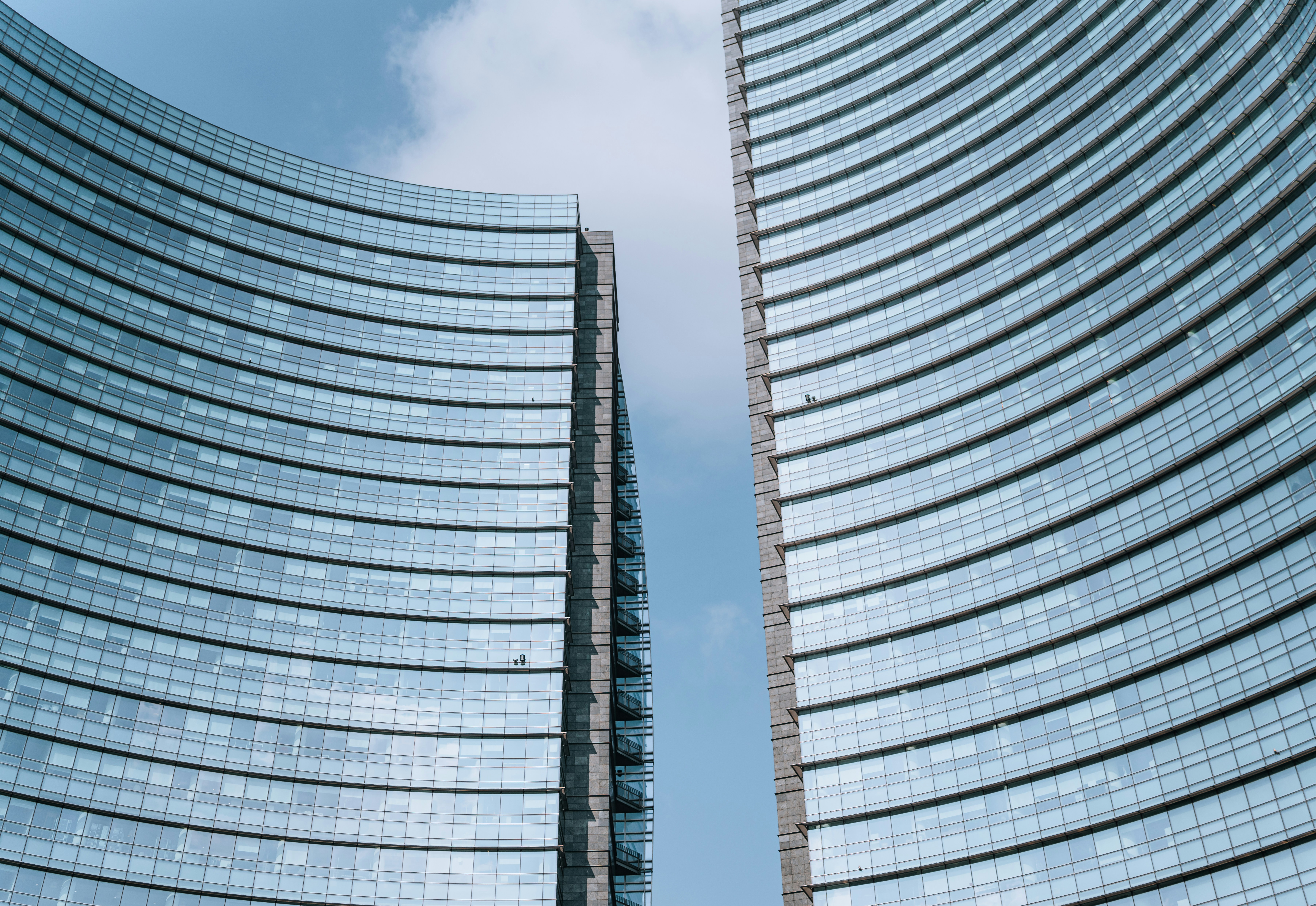 A couple of tall buildings sitting next to each other photo – Free ...