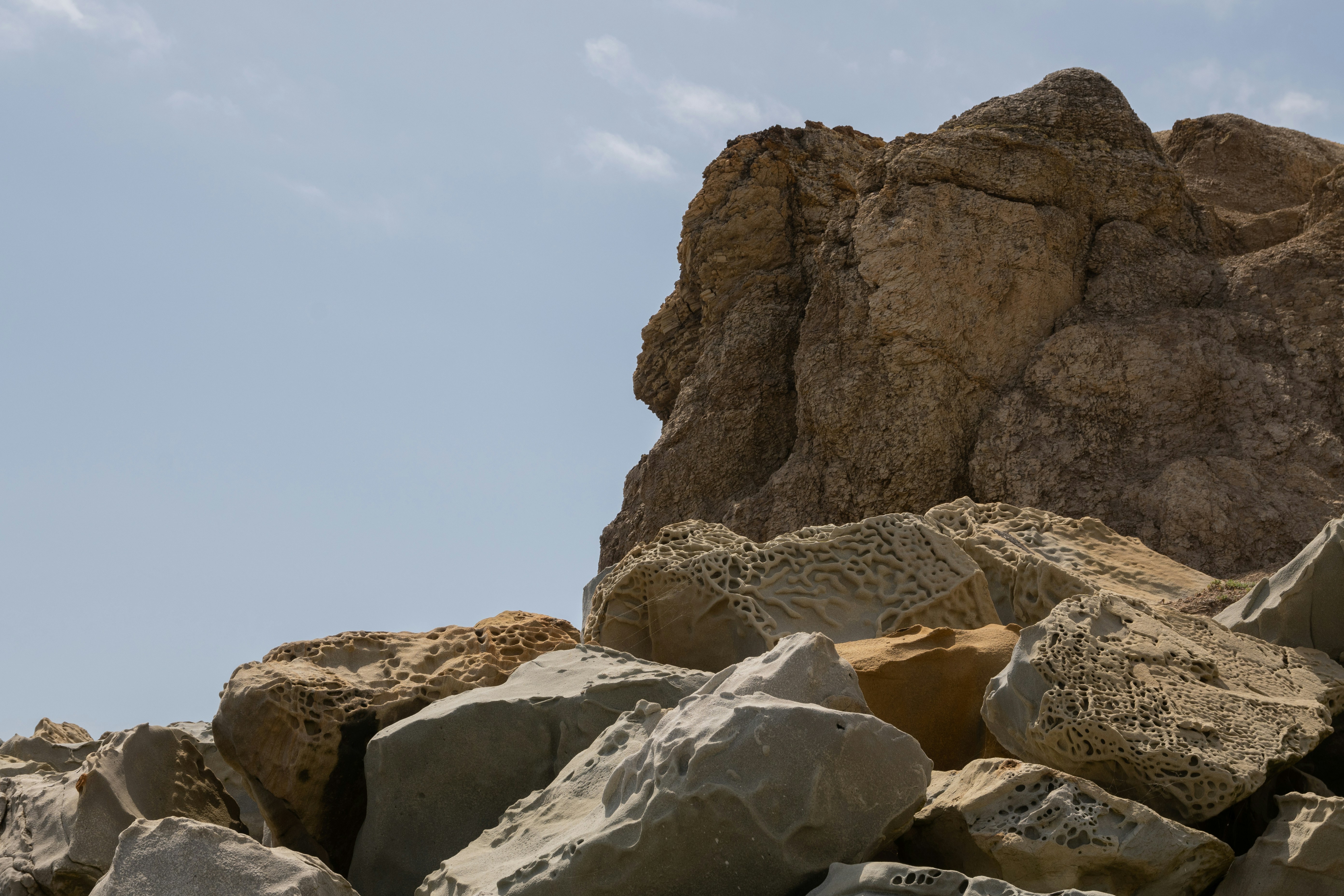 A large rock formation with a bird sitting on top of it photo – Free ...