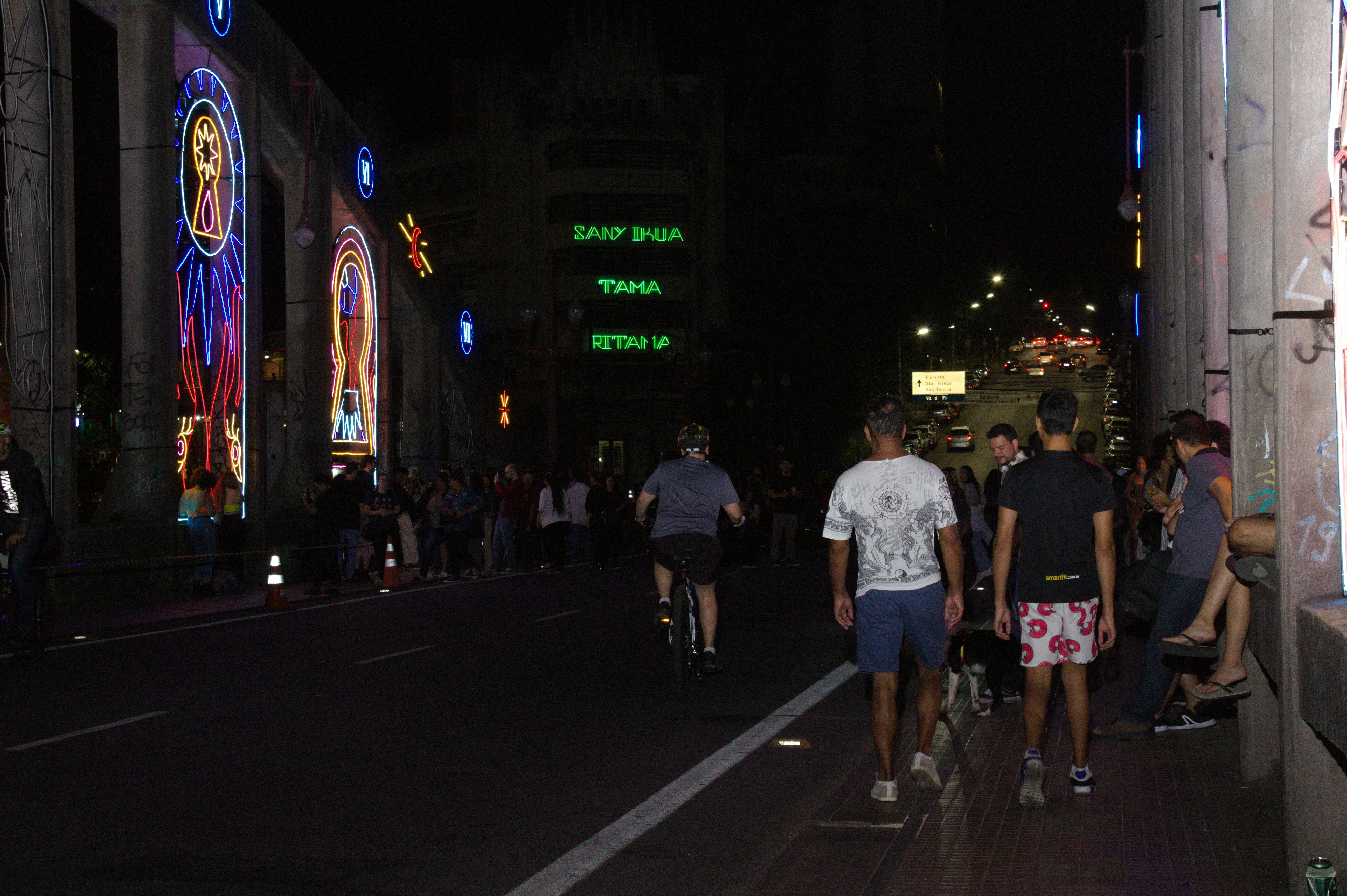 Neon Night Steps: Pedestrians Thread a Luminous Boulevard