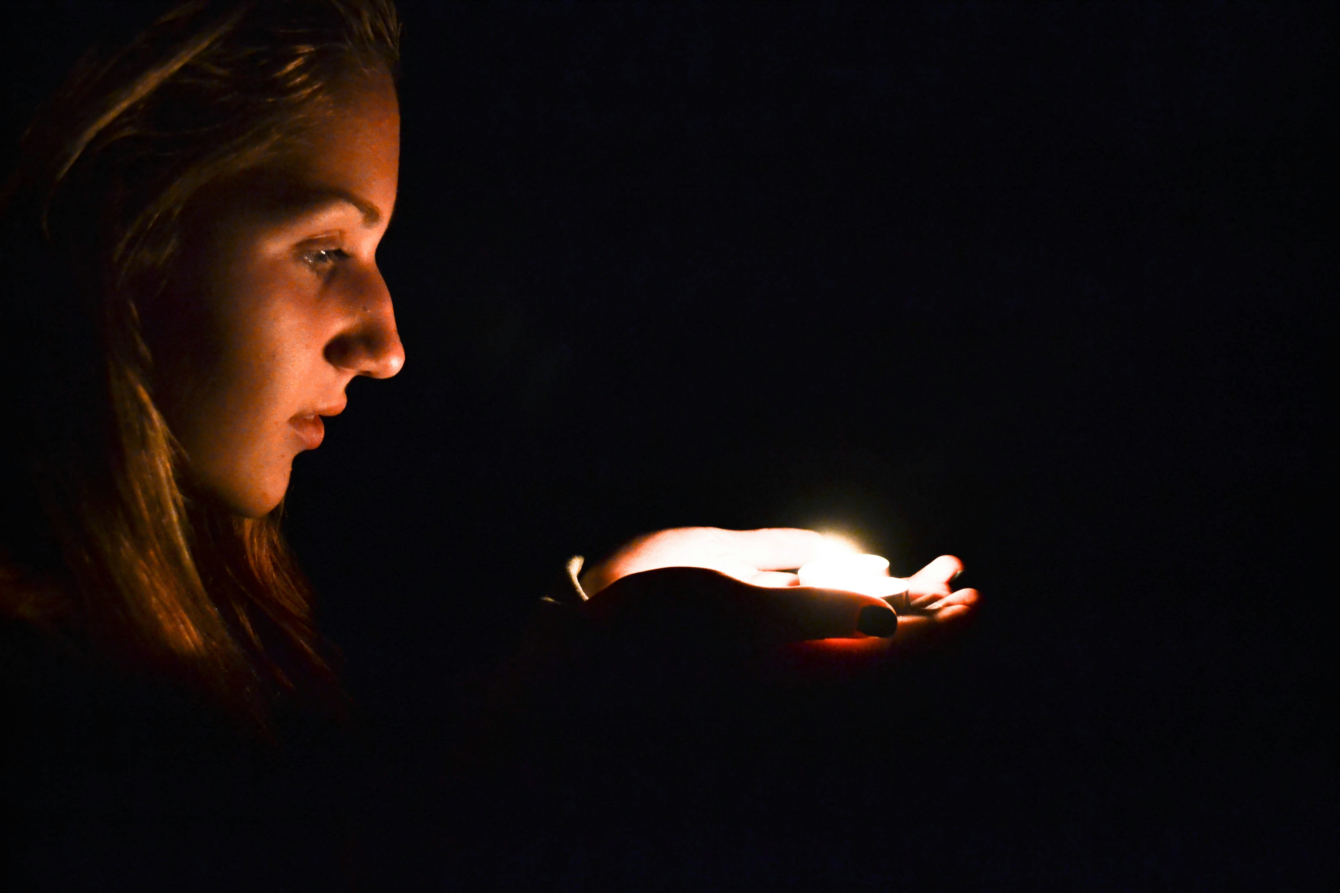 A woman holding a lit object in her hand photo – Free Ukraine Image on ...