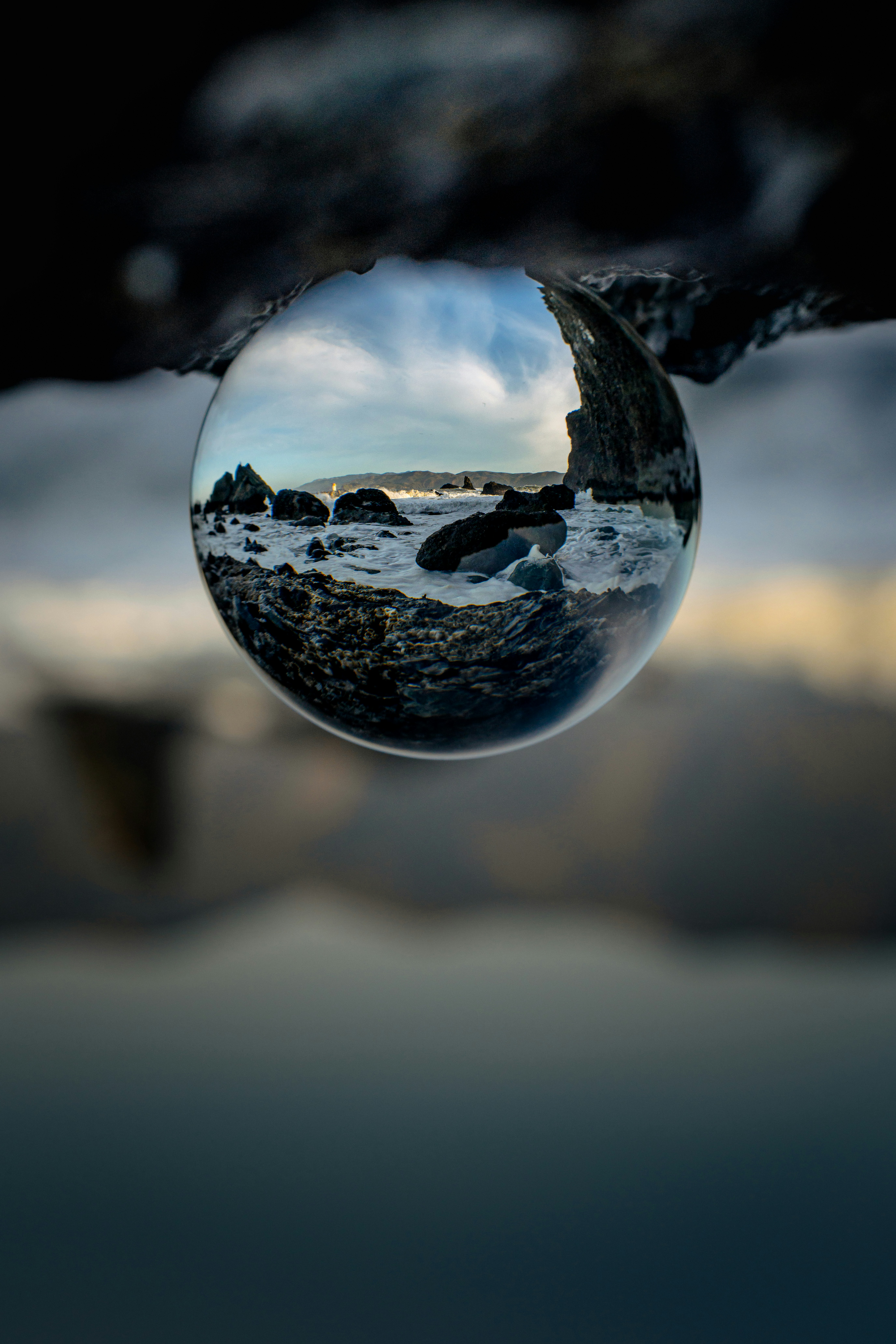 A reflection of a rocky beach in a water drop photo – Free Sphere Image ...