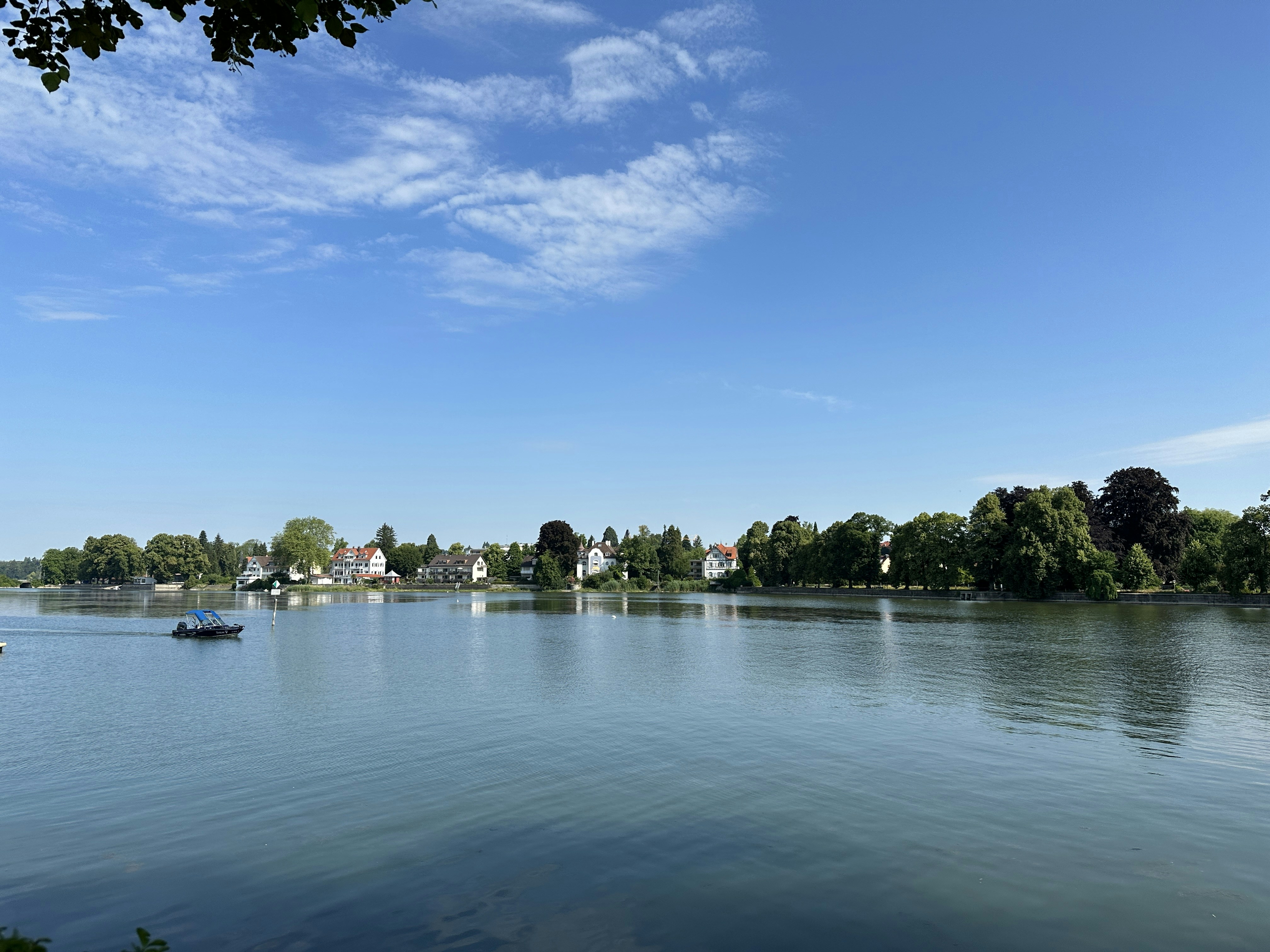a lake with a boat in the middle of it